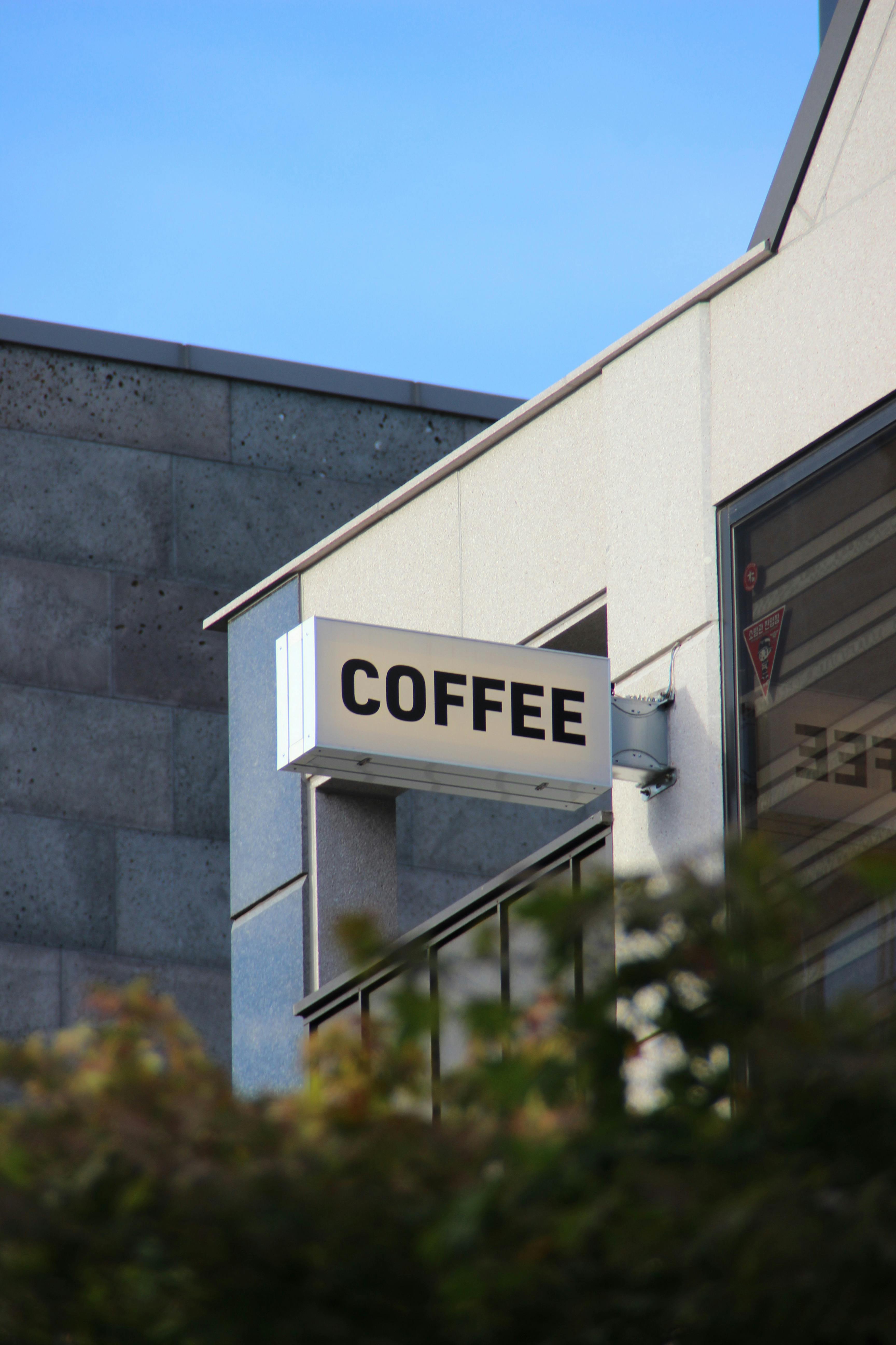 Coffeeshop Sign in Modern Seoul Cityscape · Free Stock Photo