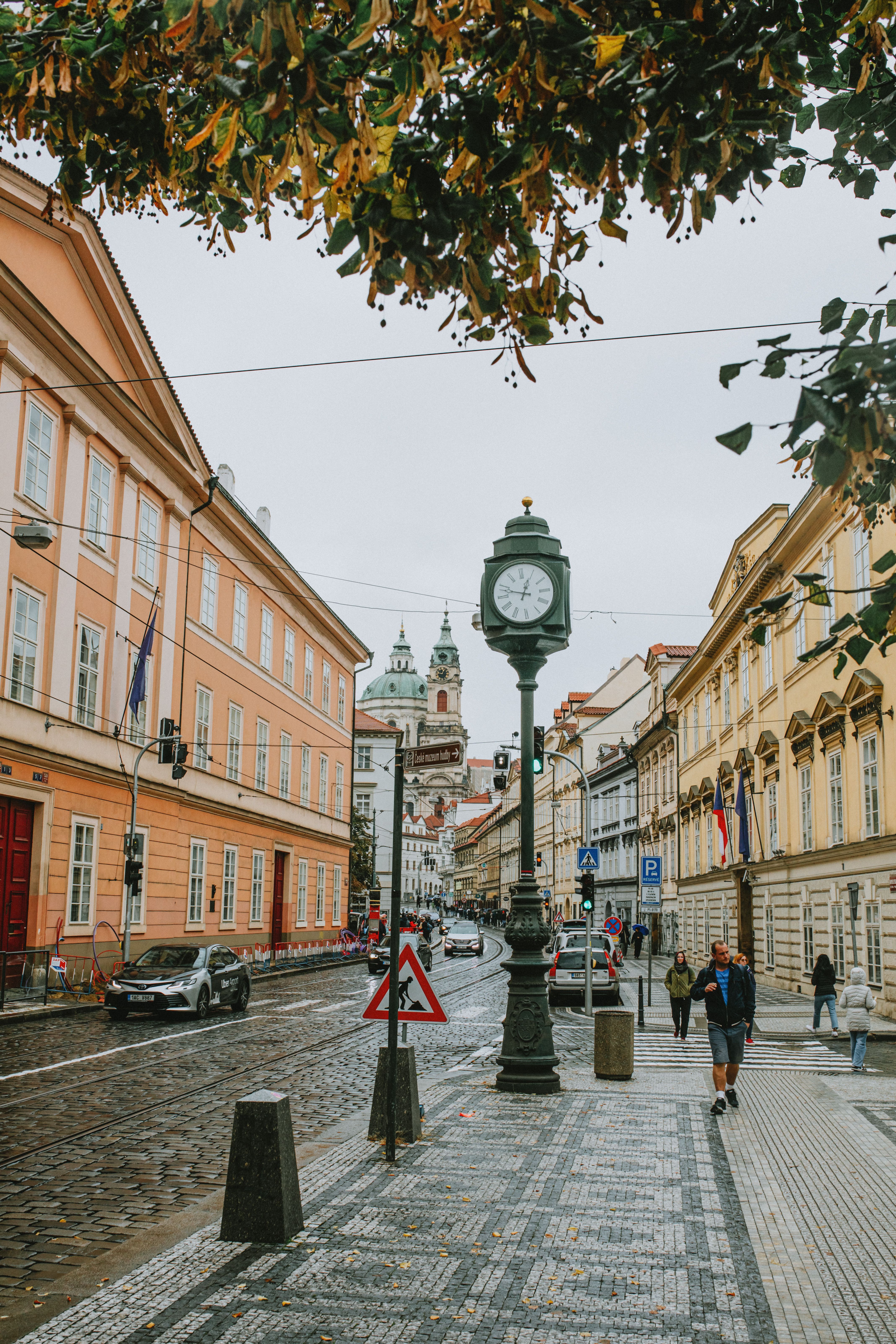 Scenic European Street with Historic Clock Tower · Free Stock Photo