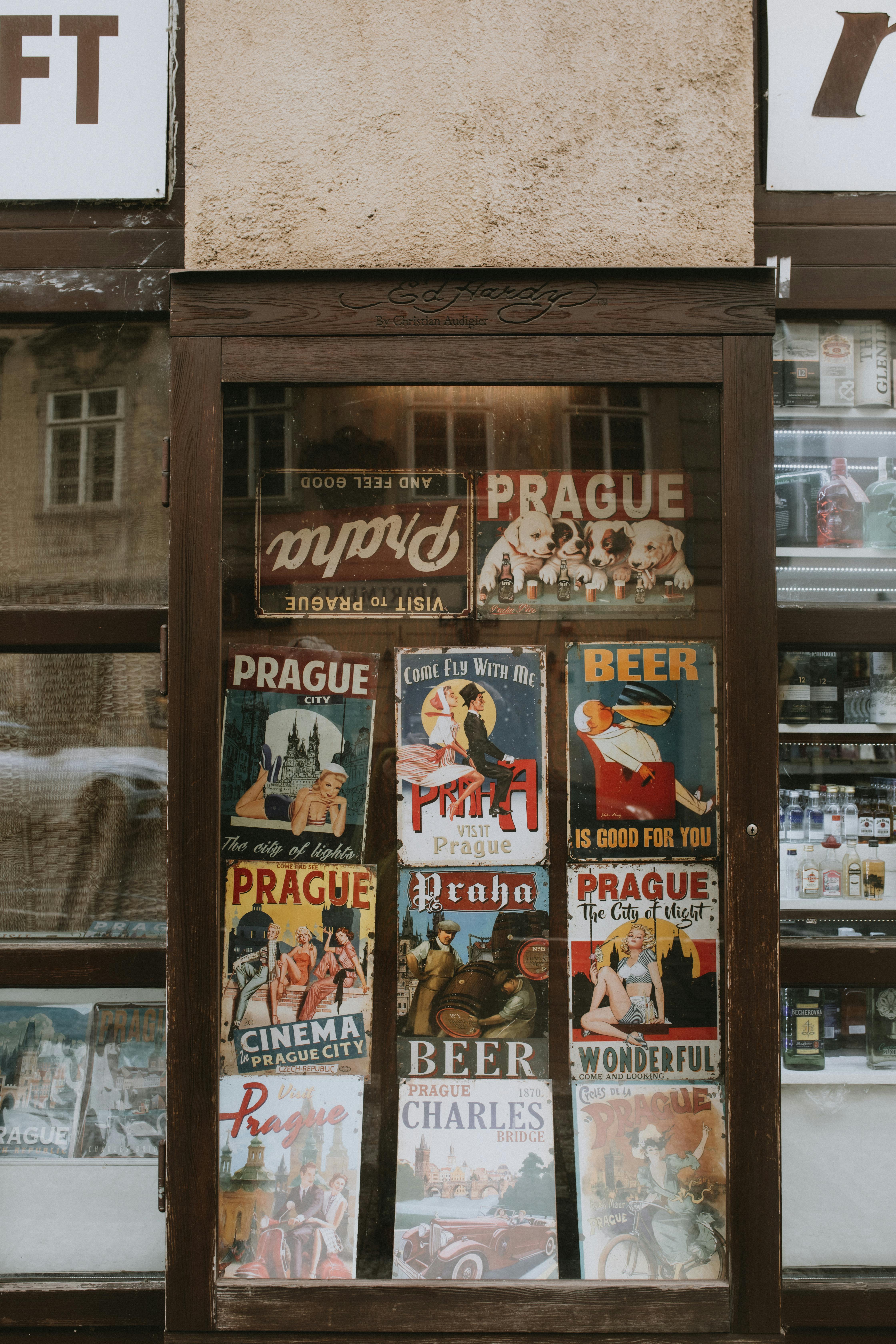Vintage Prague Posters Display in Shop Window · Free Stock Photo