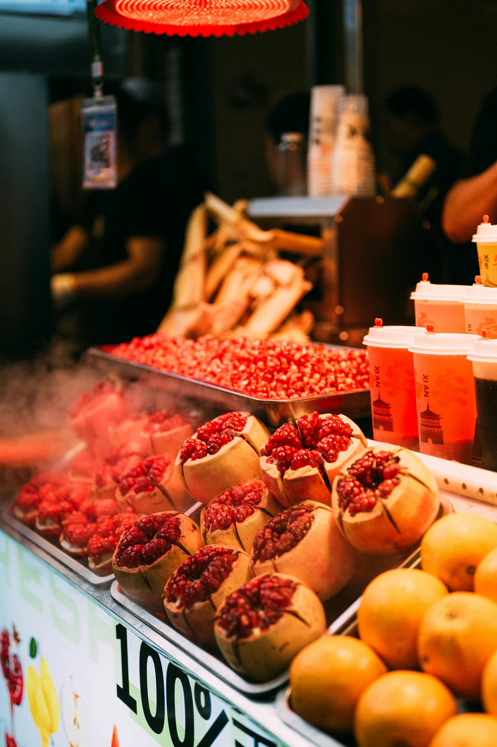 Vibrant Street Market Display with Fresh Pomegranates · Free Stock Photo