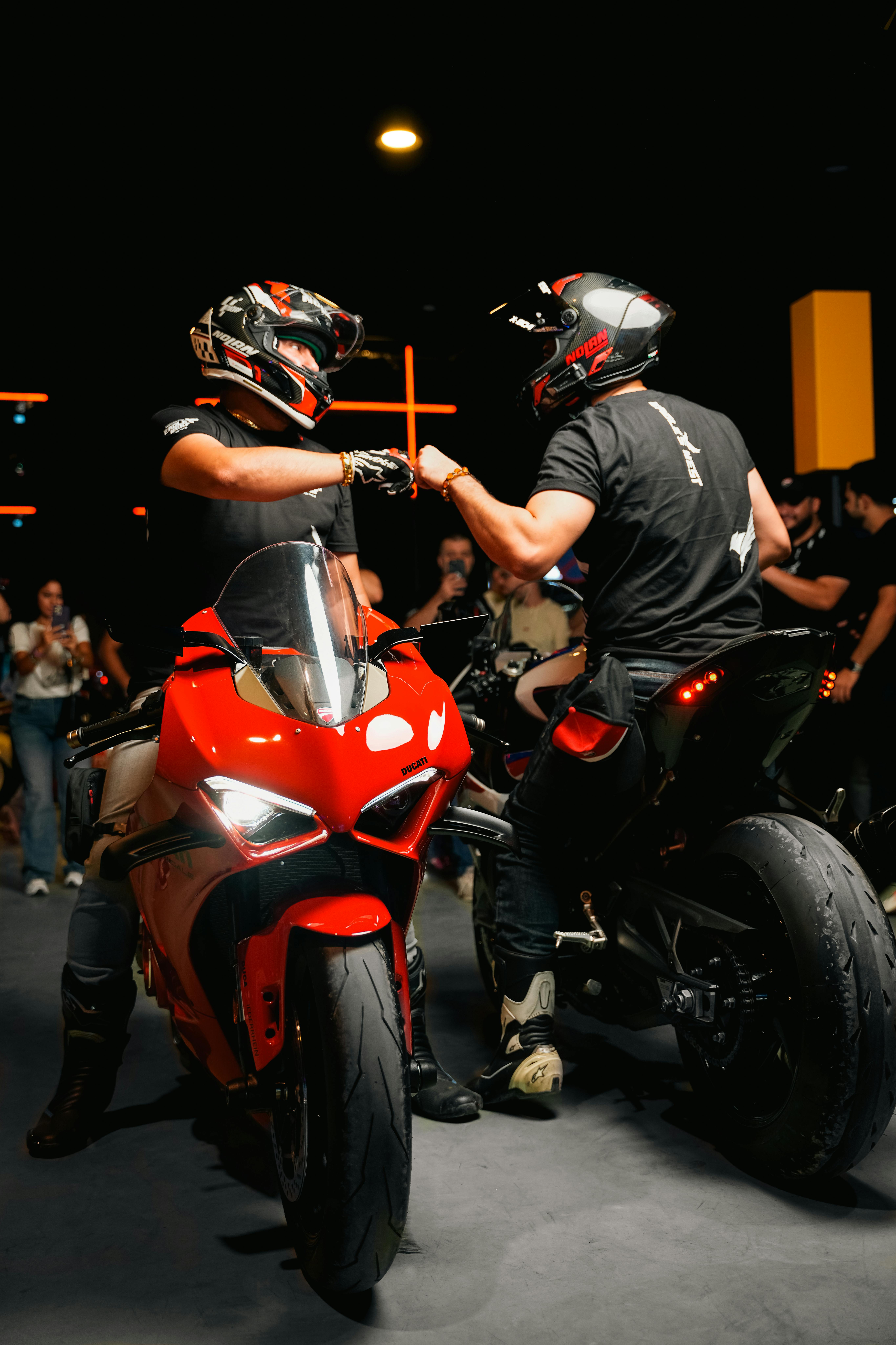 Bikers Fist Bumping in Urban Night Scene · Free Stock Photo