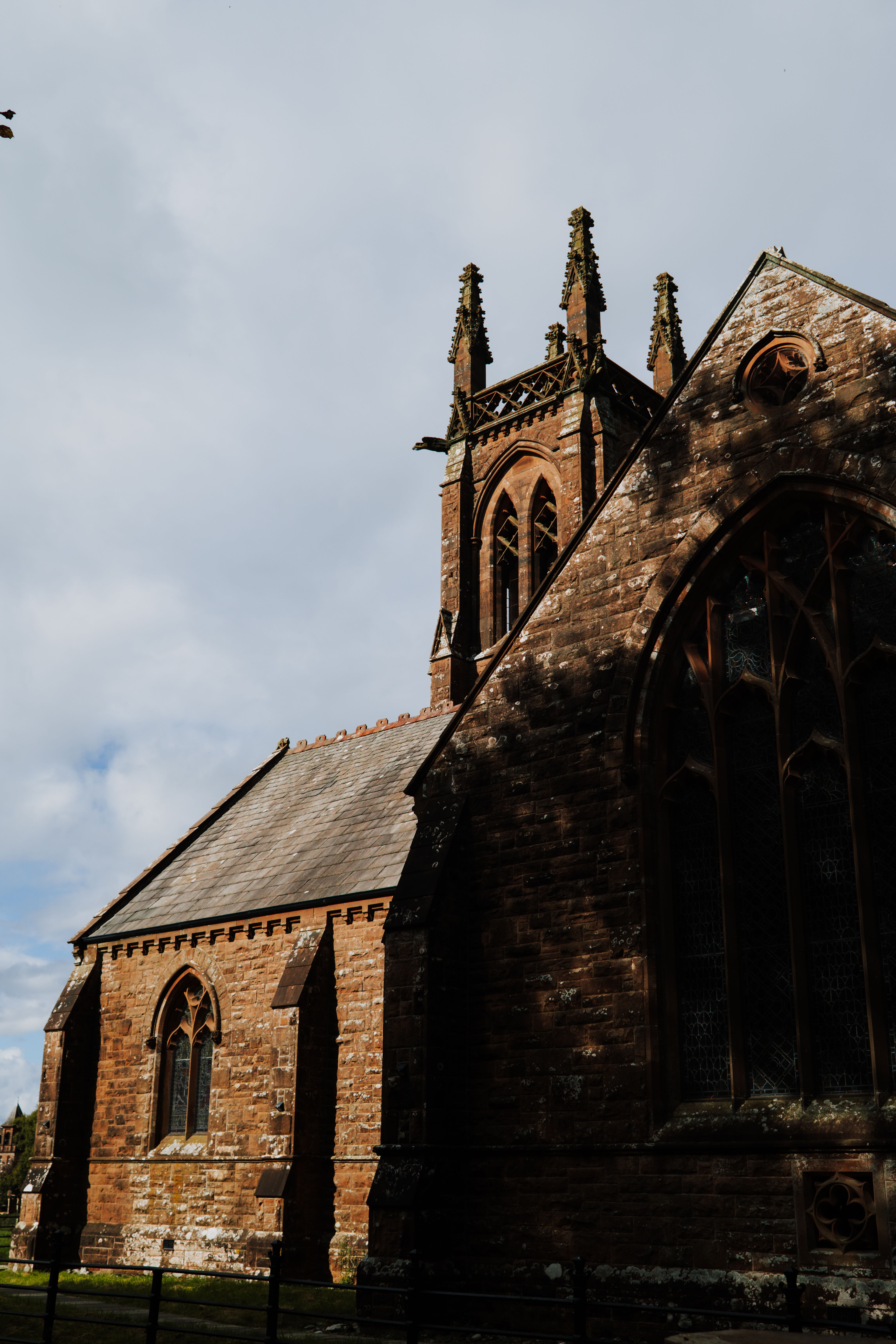 Historic Stone Church Against Cloudy Sky · Free Stock Photo