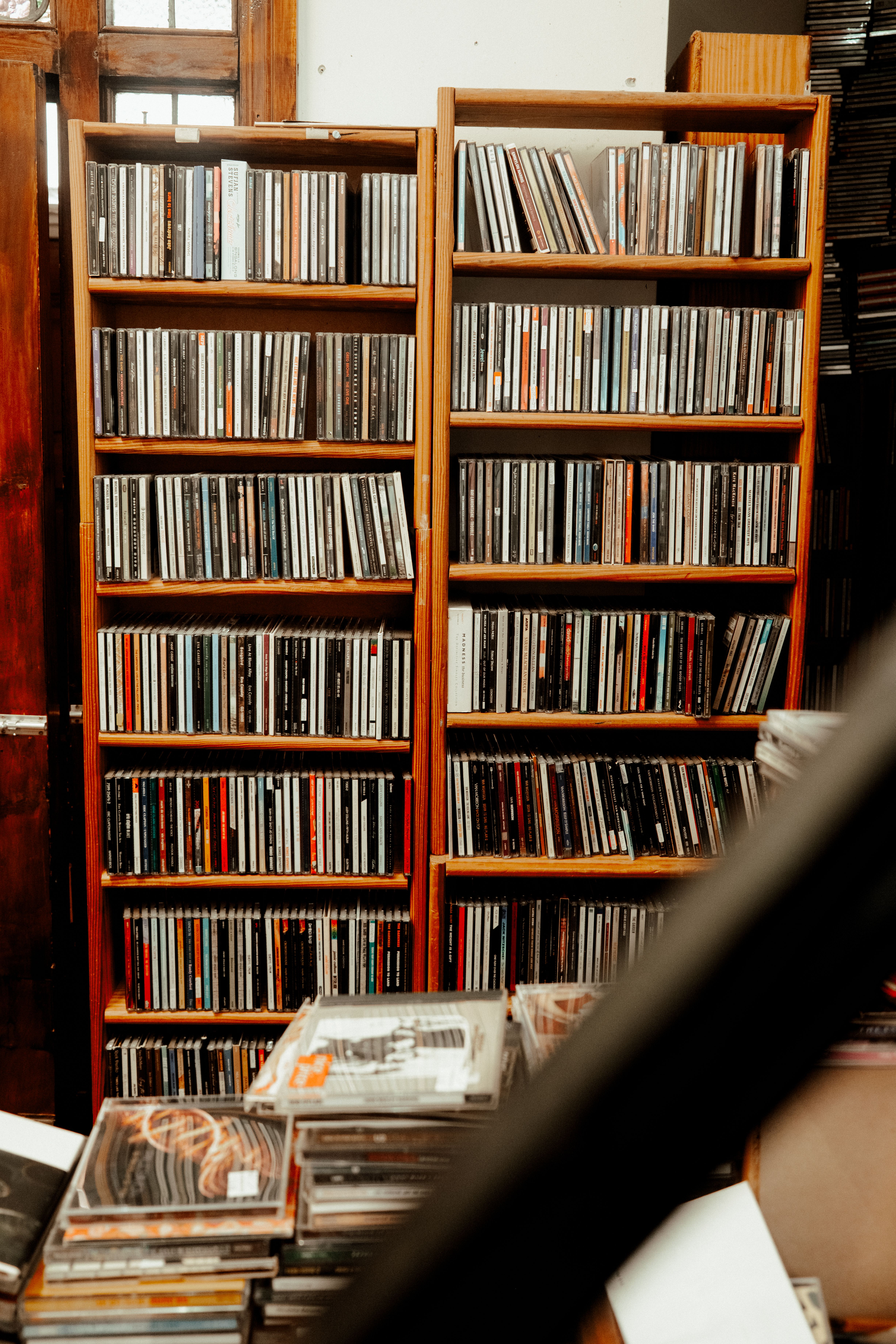 Wooden Bookshelf Filled with Music CDs in Cozy Room · Free Stock Photo