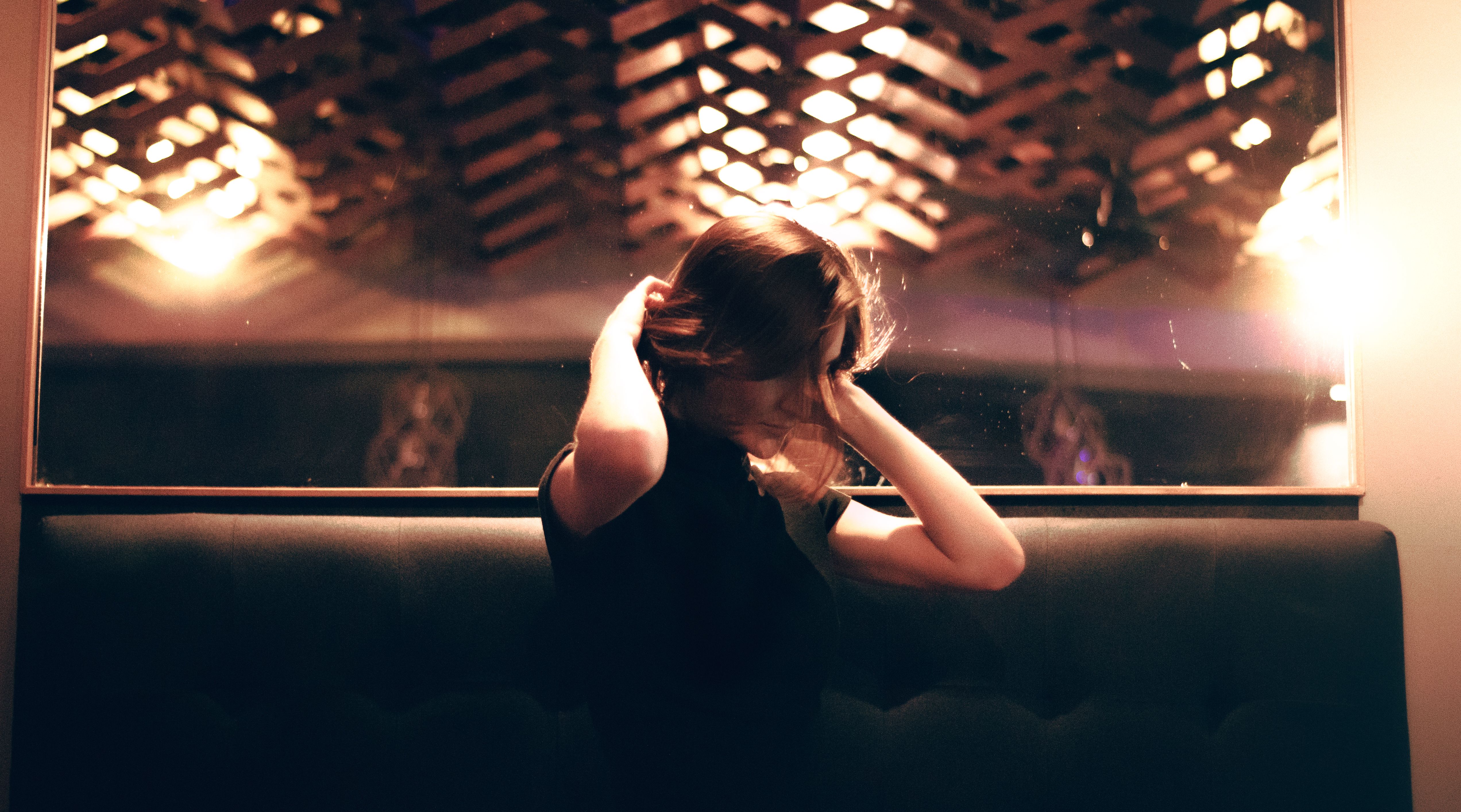 Woman in dimly lit restaurant interior · Free Stock Photo