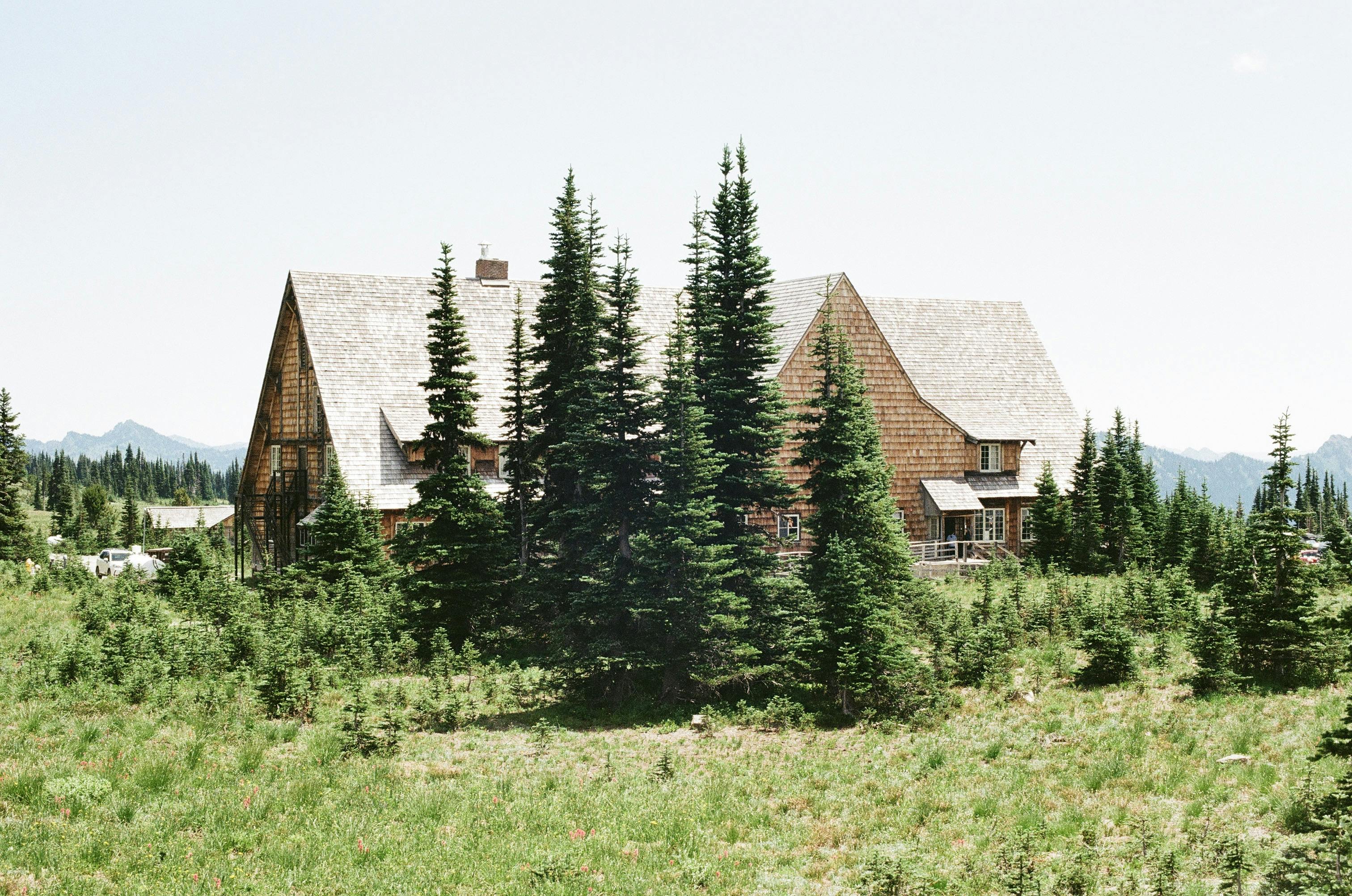 Rustic Lodge in Forested Mountain Landscape · Free Stock Photo