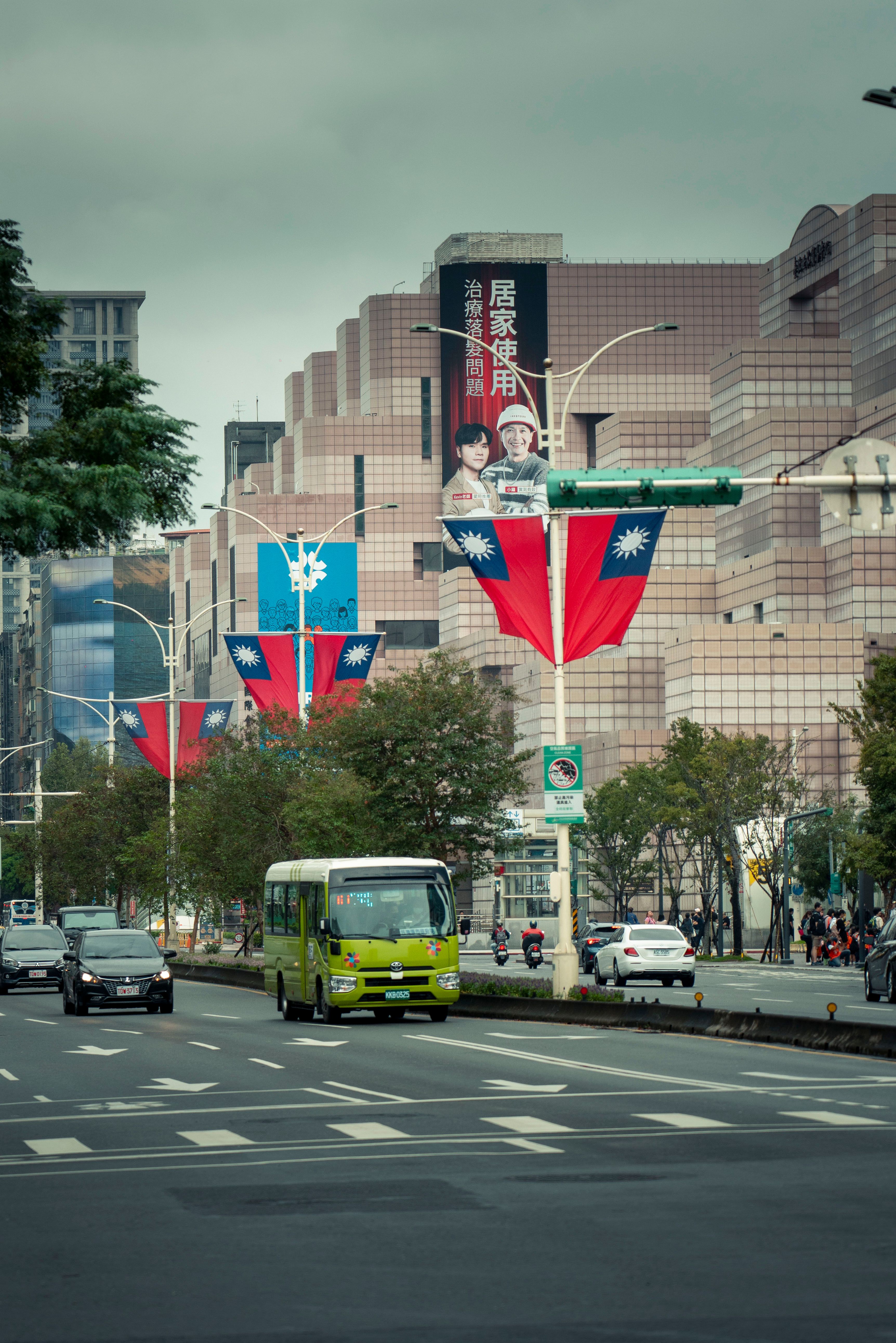 Vibrant Streetscape of Taipei with Flags and Traffic · Free Stock Photo