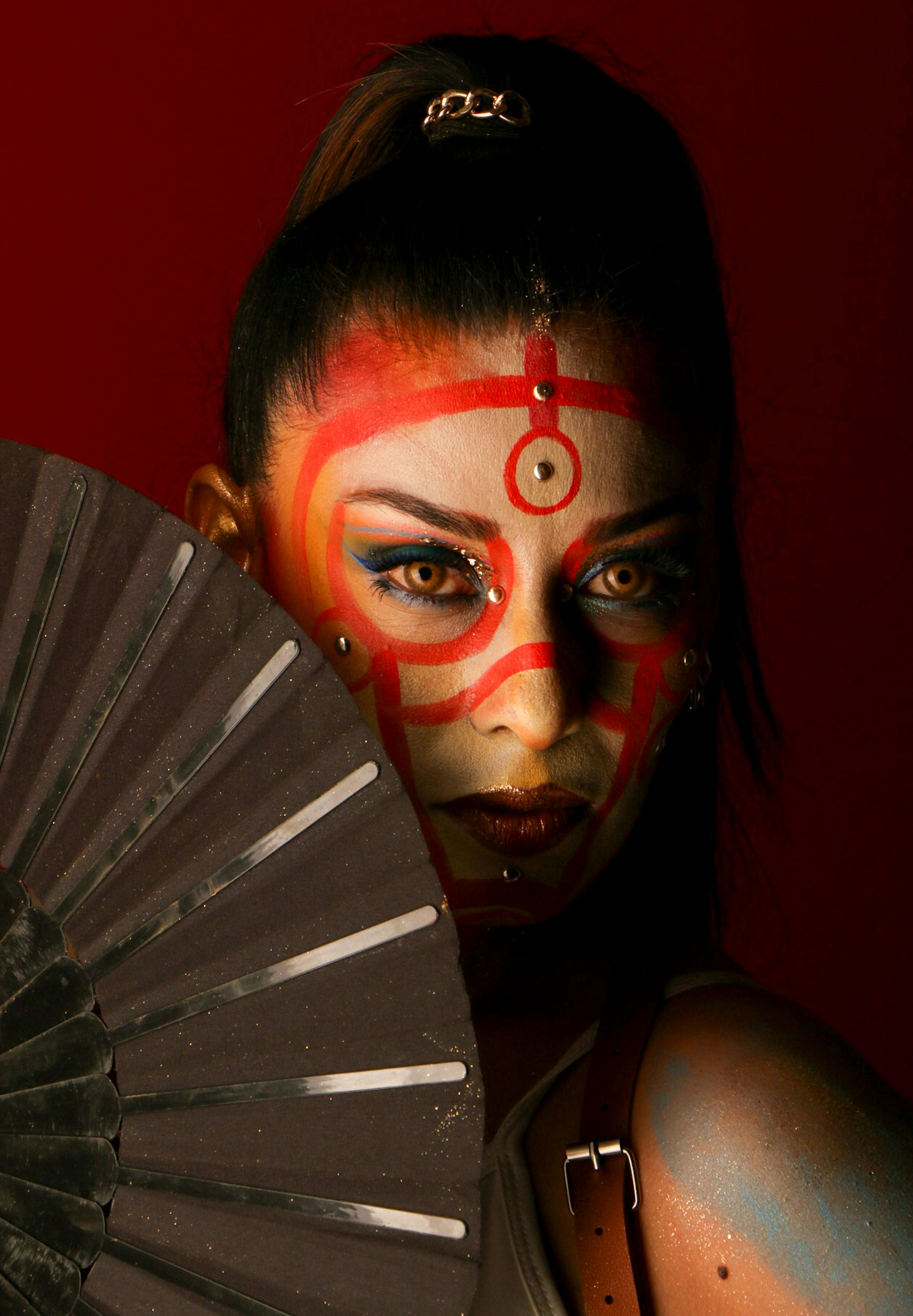 Dramatic Portrait of Woman with Face Paint and Fan · Free Stock Photo