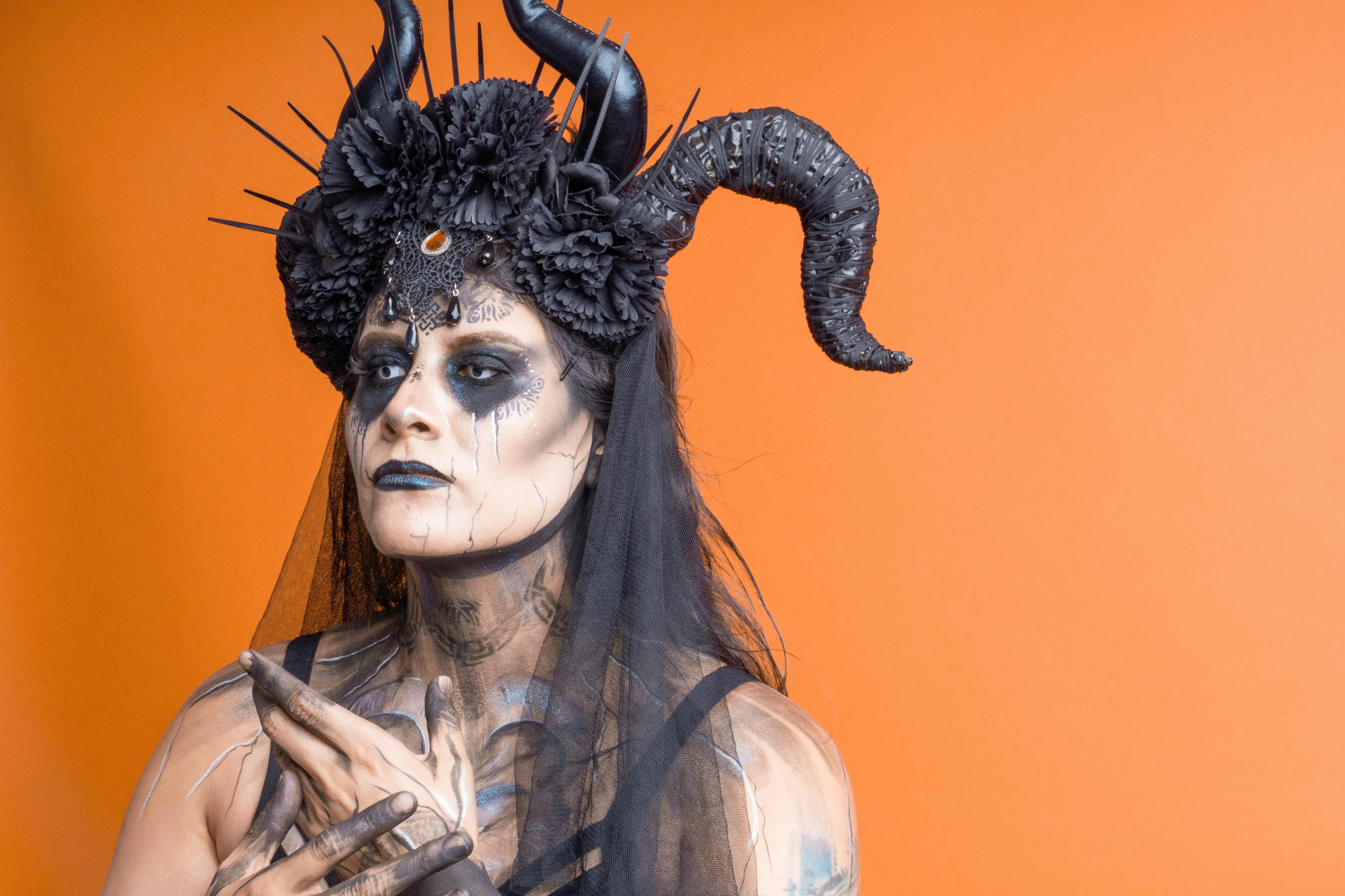 Halloween Makeup with Horns and Orange Background · Free Stock Photo