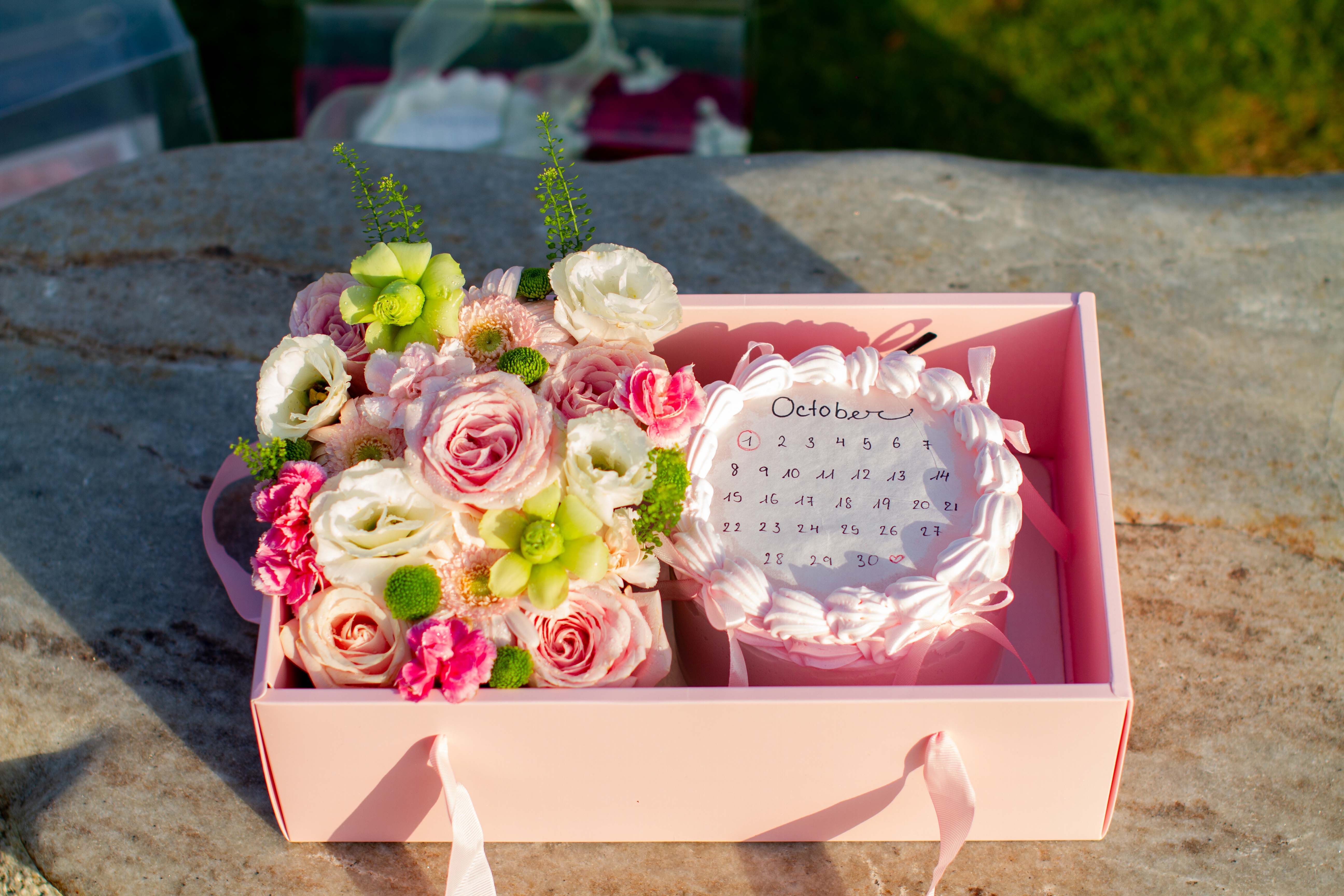 Elegant Flower Arrangement with Calendar in Pink Box · Free Stock Photo