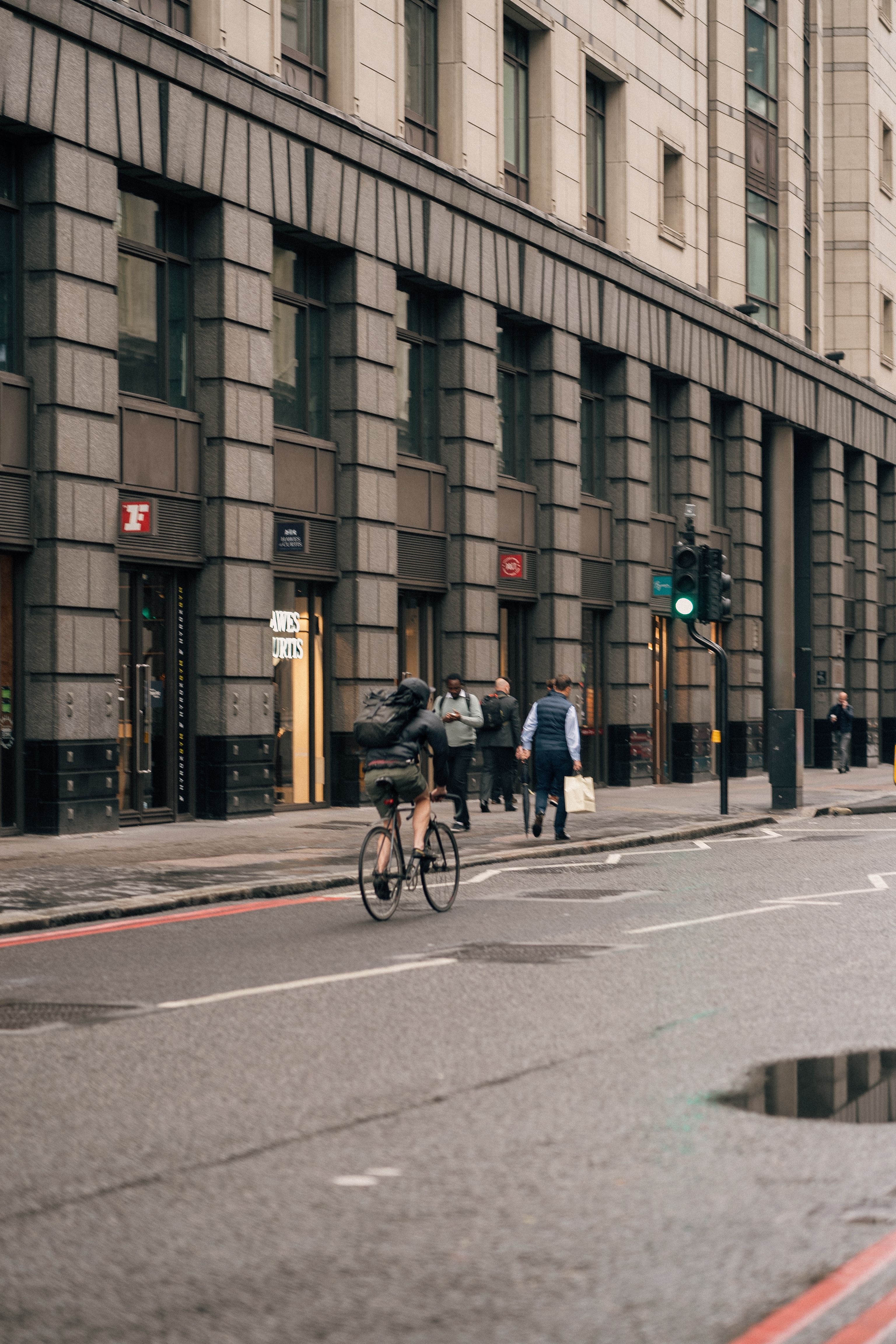 Urban Street Scene with Cyclist and Pedestrians · Free Stock Photo