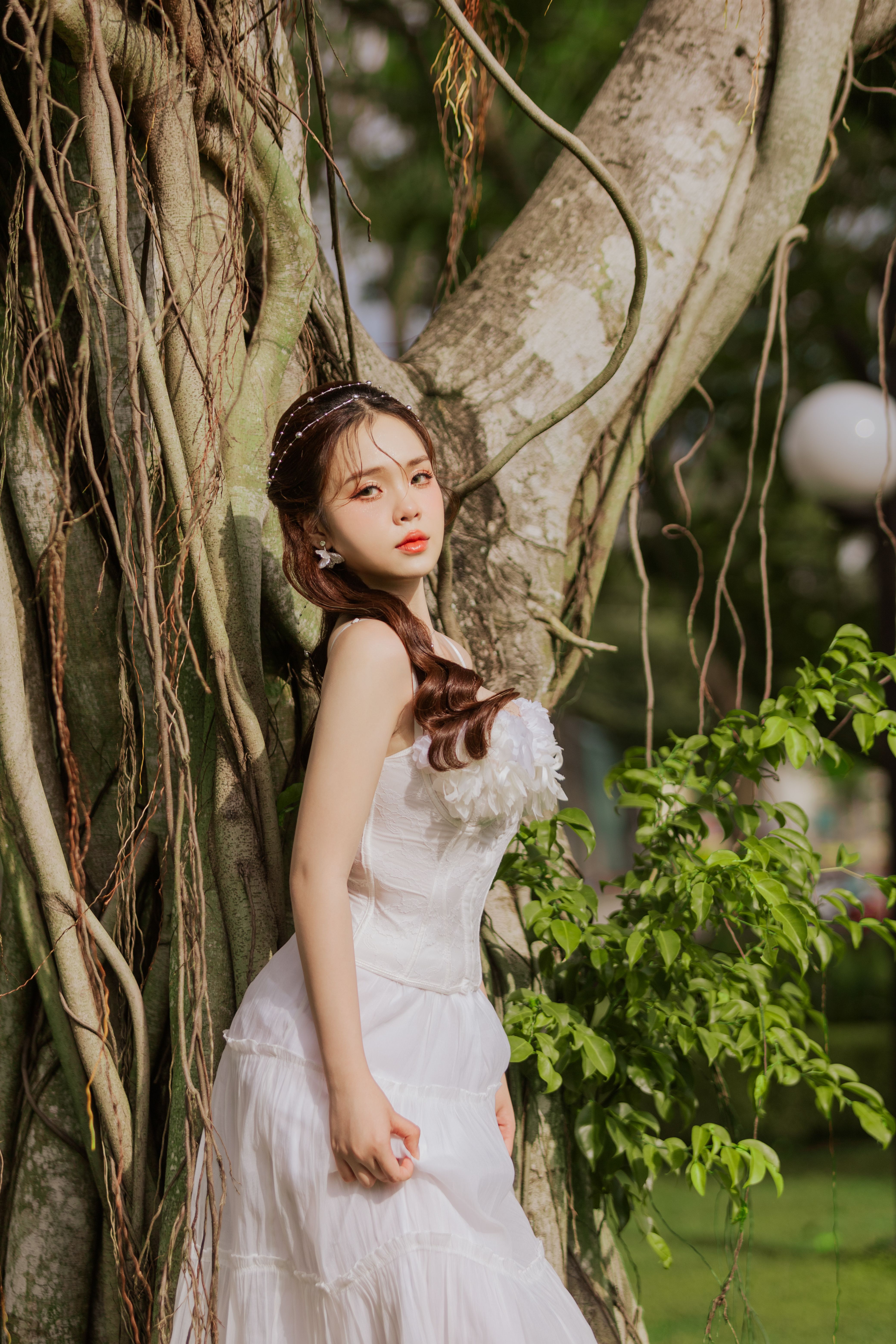 Woman in Dress Standing Beside Tree · Free Stock Photo