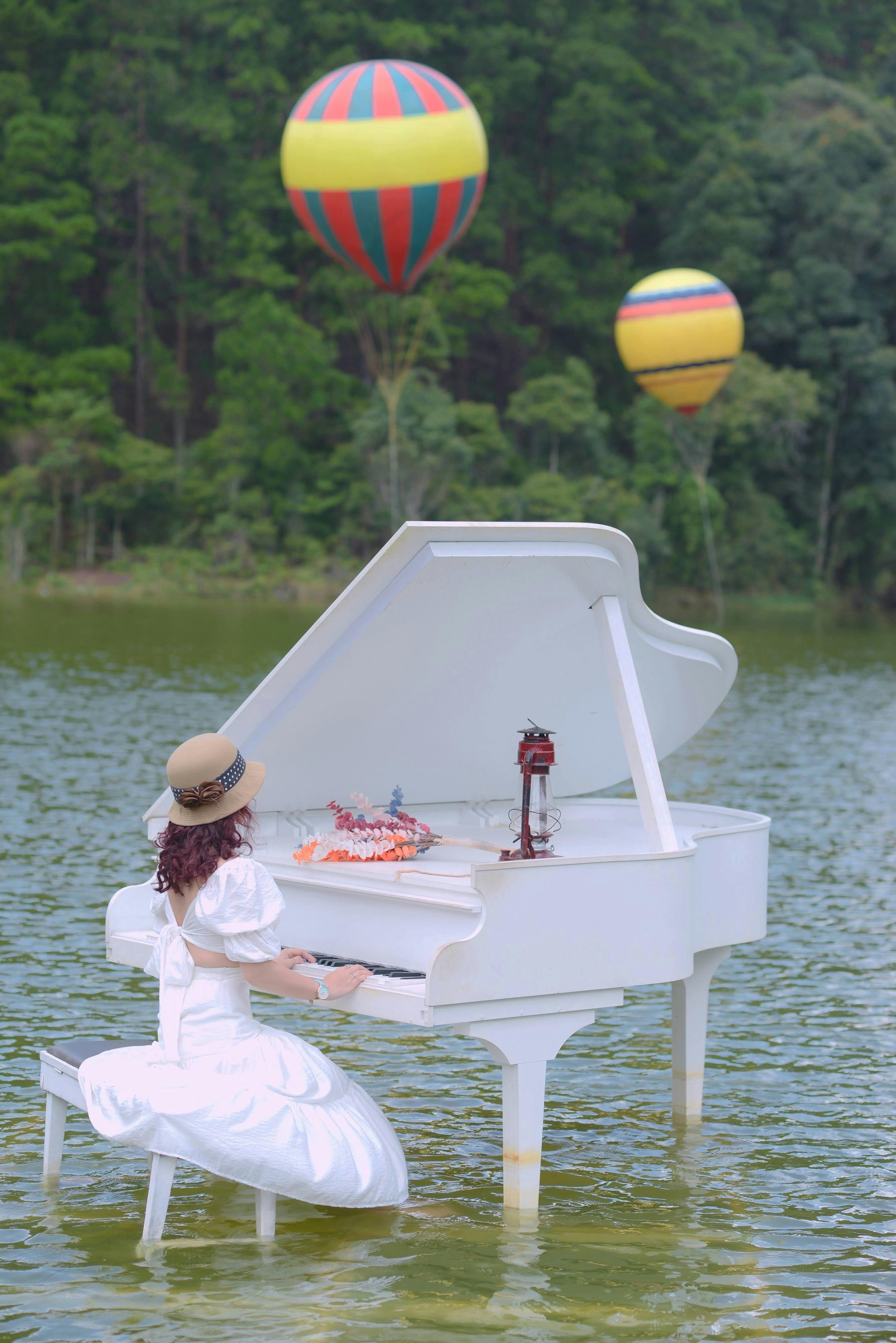 Whimsical Scene of a Woman Playing Piano in Lake with Hot Air Balloons ...