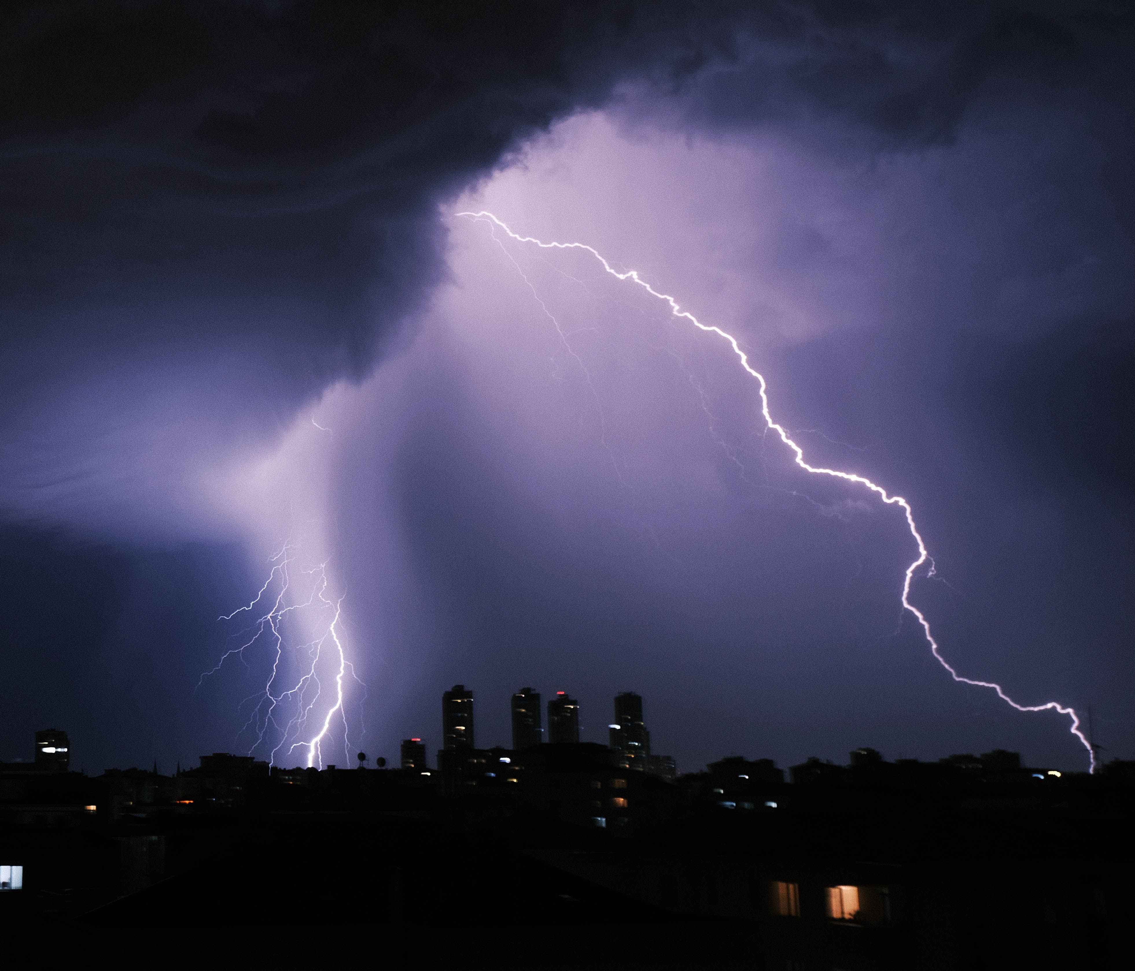 Dramatic Cityscape with Lightning Storm at Night · Free Stock Photo