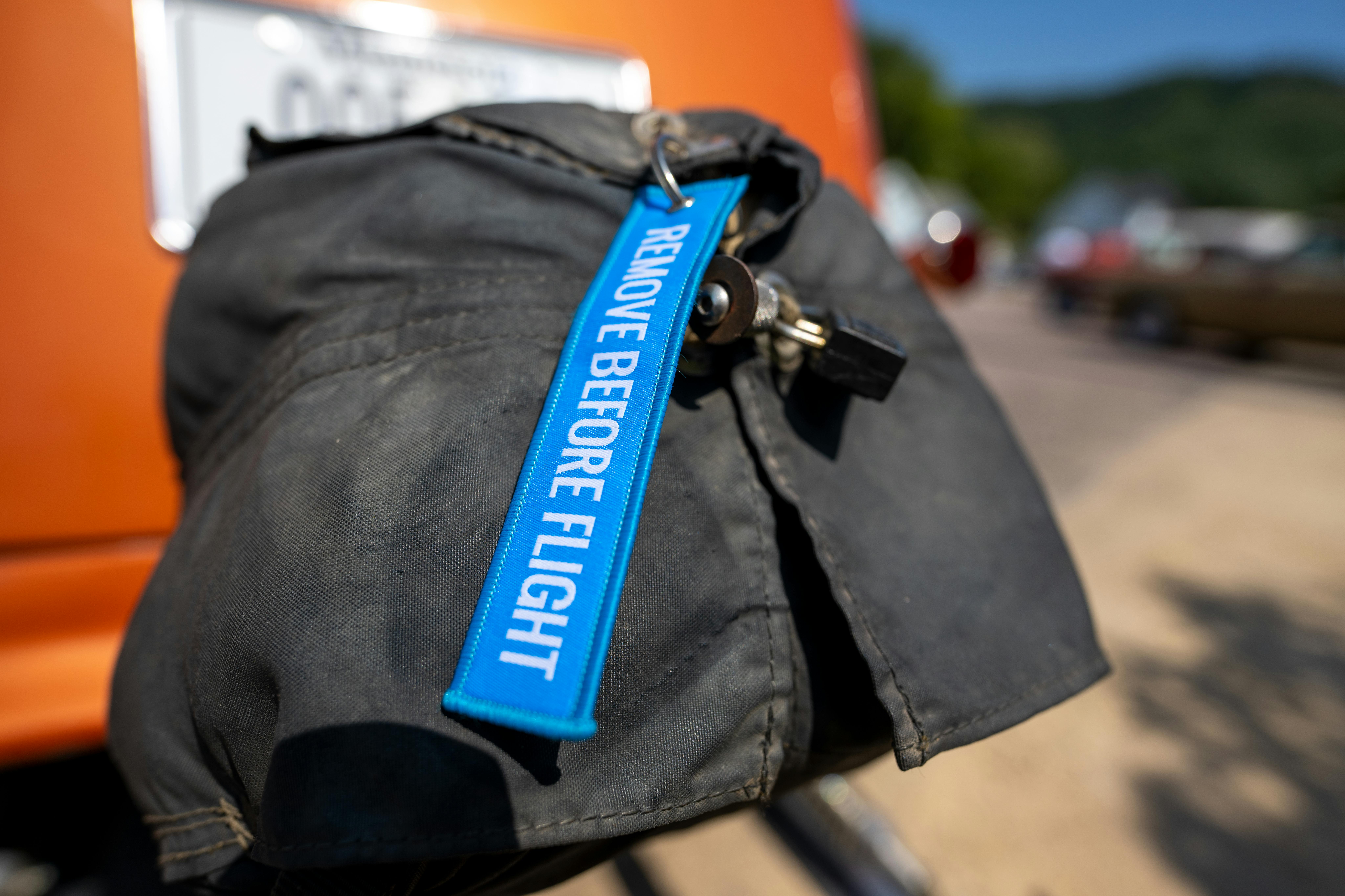 Close-up of Remove Before Flight Tag on Car · Free Stock Photo