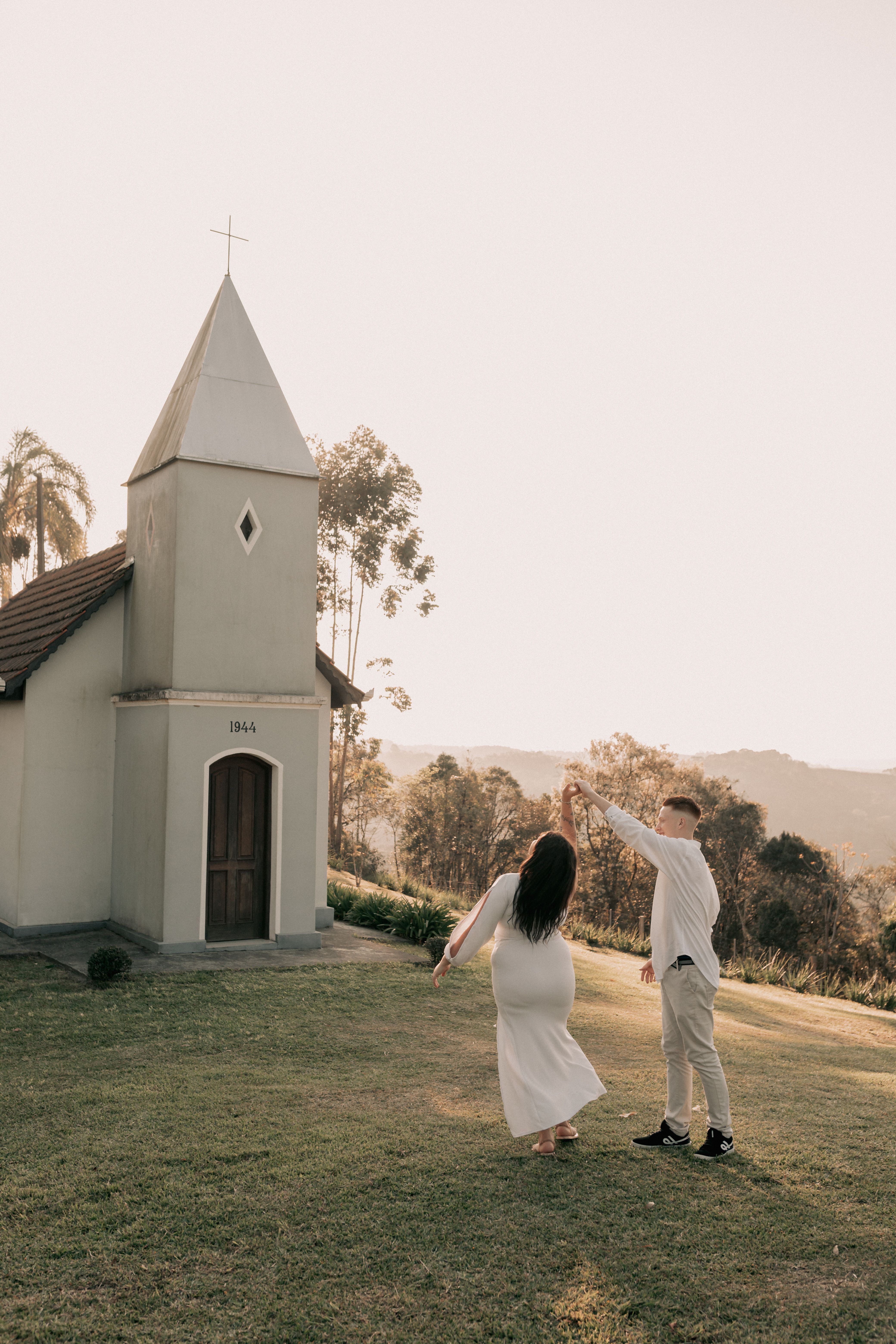 Romantic couple dancing outside a quaint chapel · Free Stock Photo