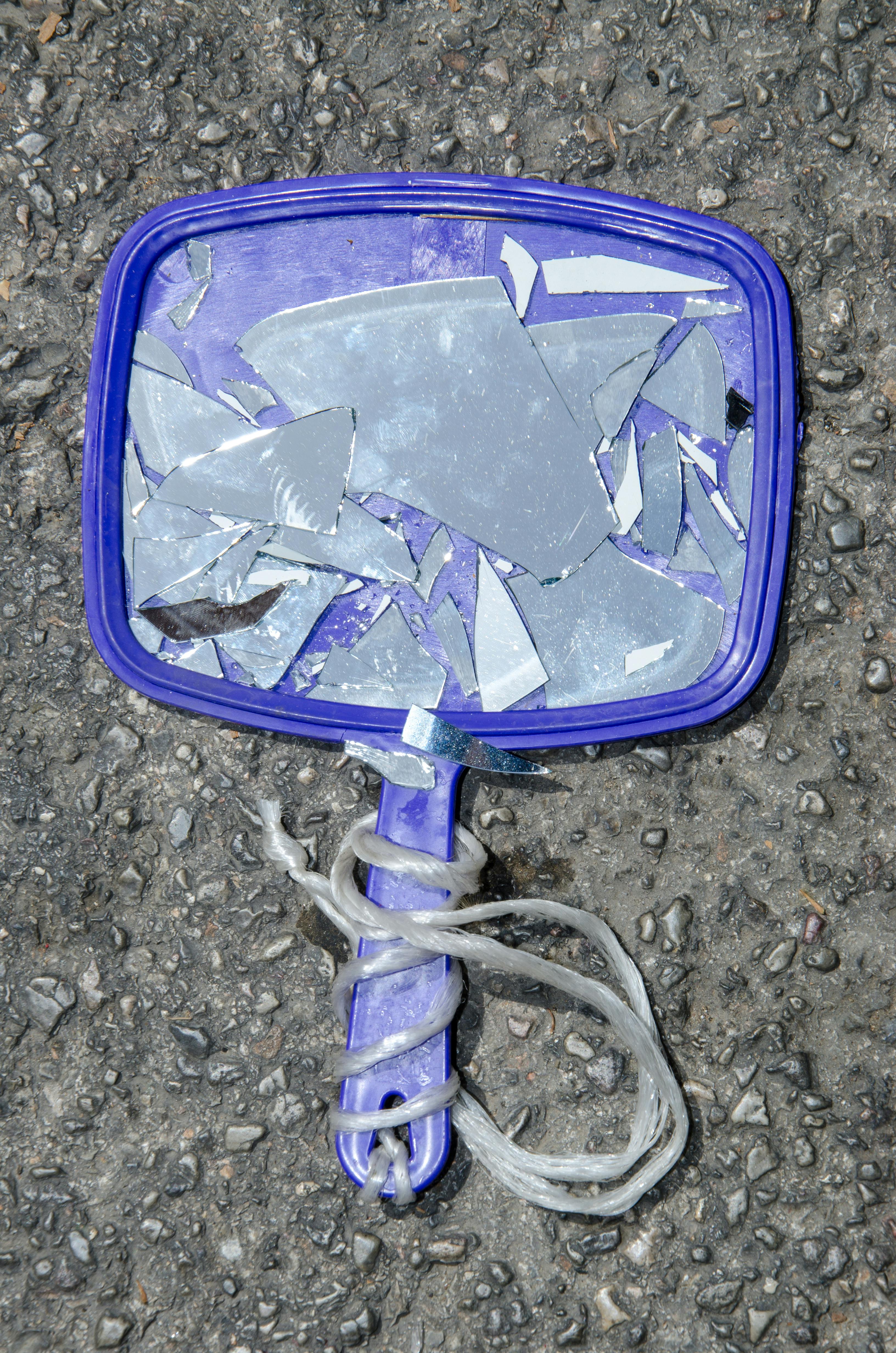 Broken Hand Mirror on Asphalt Surface · Free Stock Photo