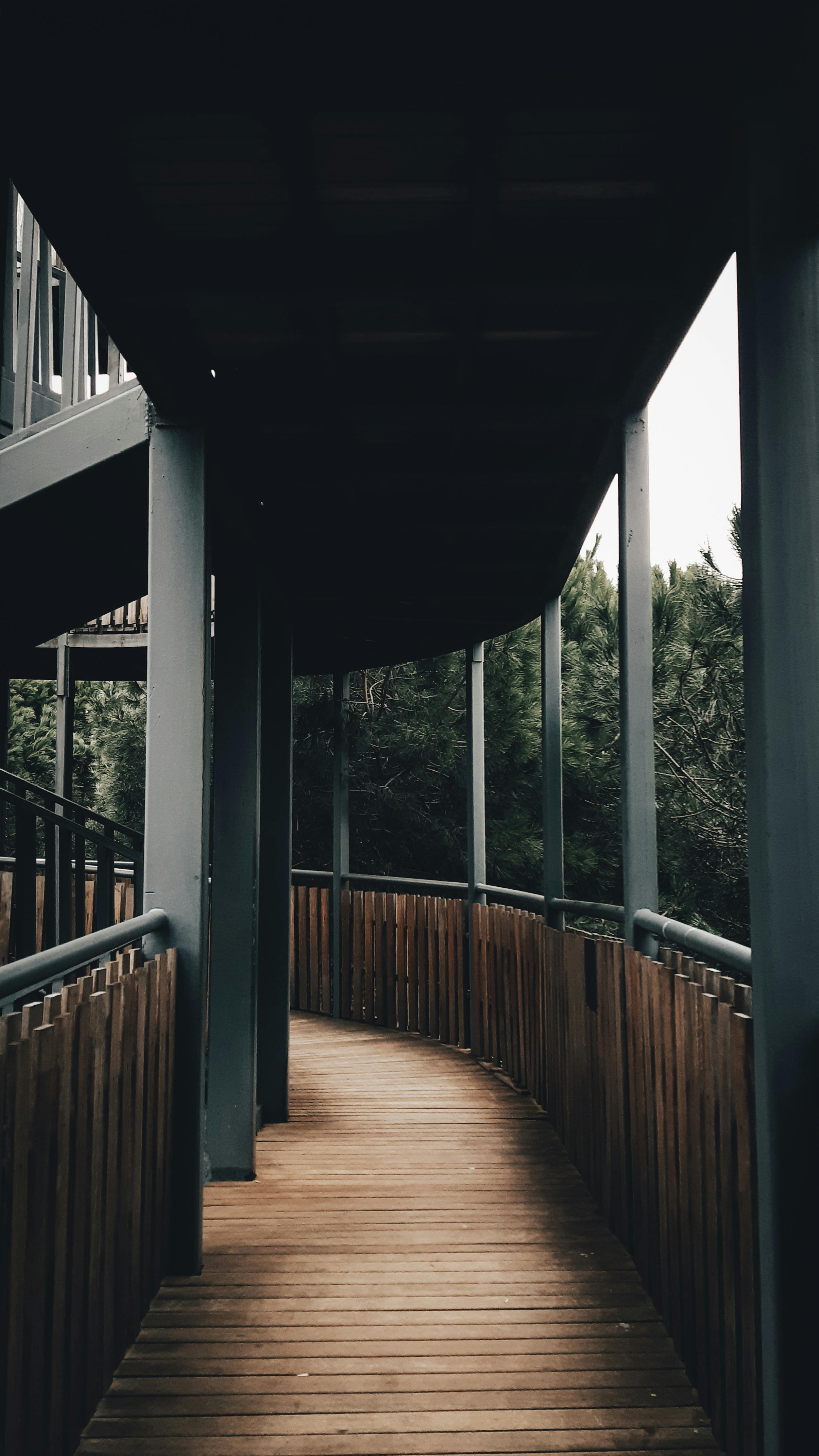 Wooden Pathway with Industrial Structures · Free Stock Photo