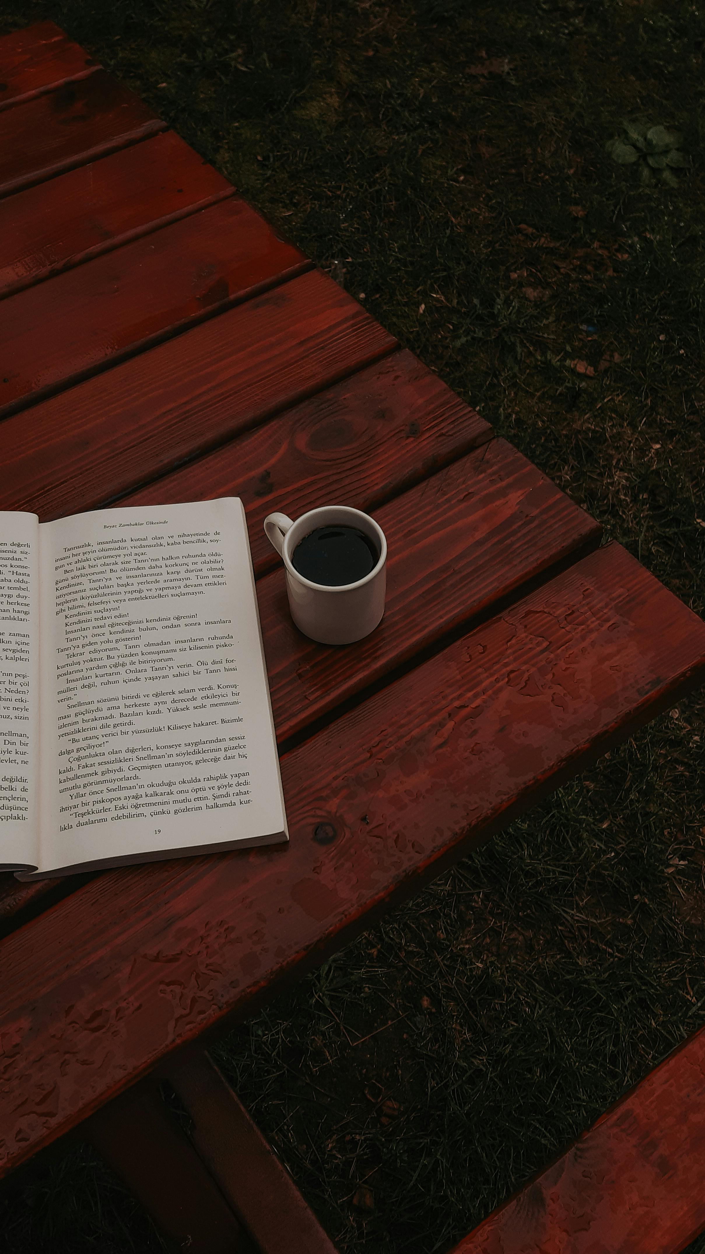 Serene Picnic Table View with Coffee and Book · Free Stock Photo