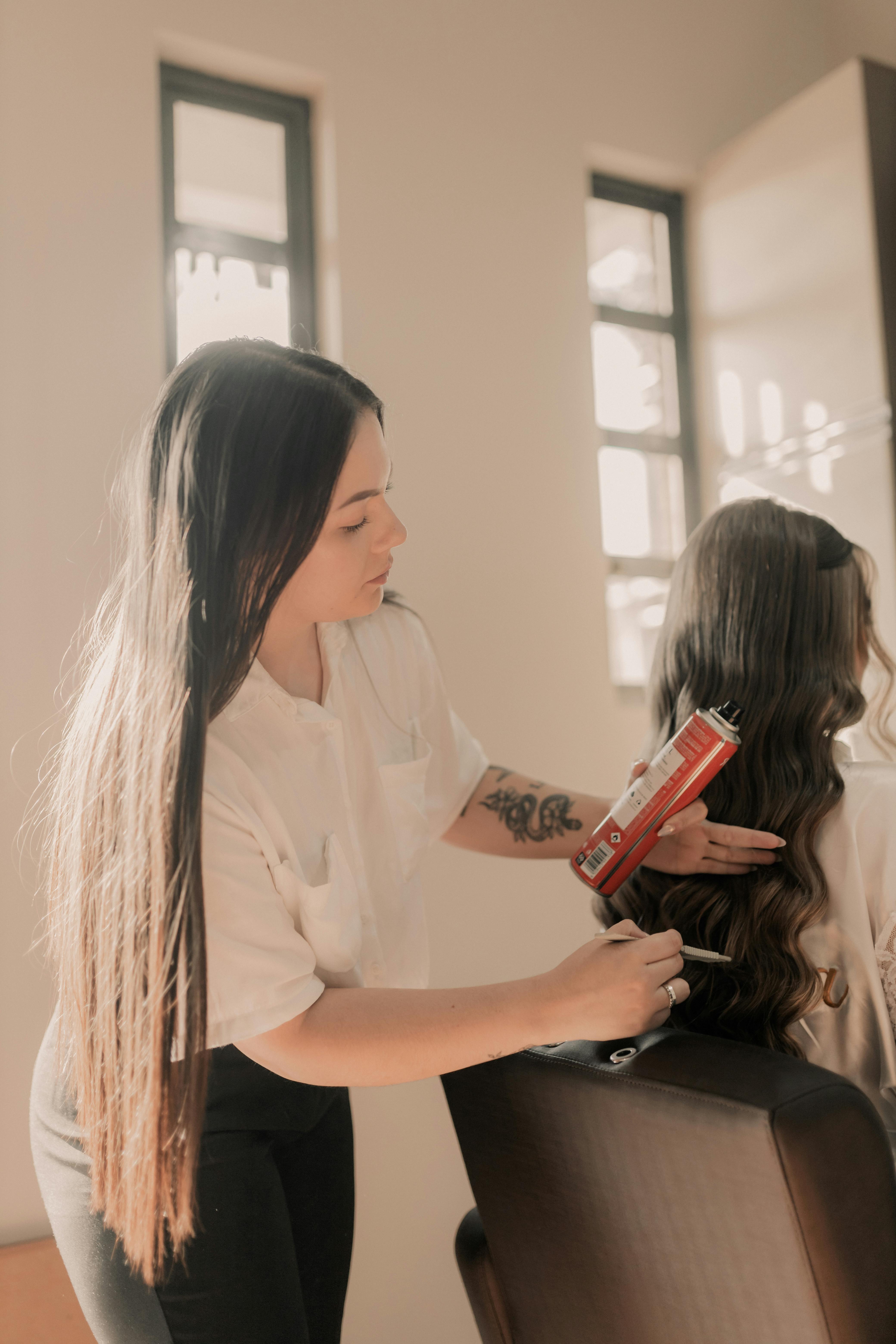 Professional Hair Stylist Curling Client's Hair in Salon · Free Stock Photo