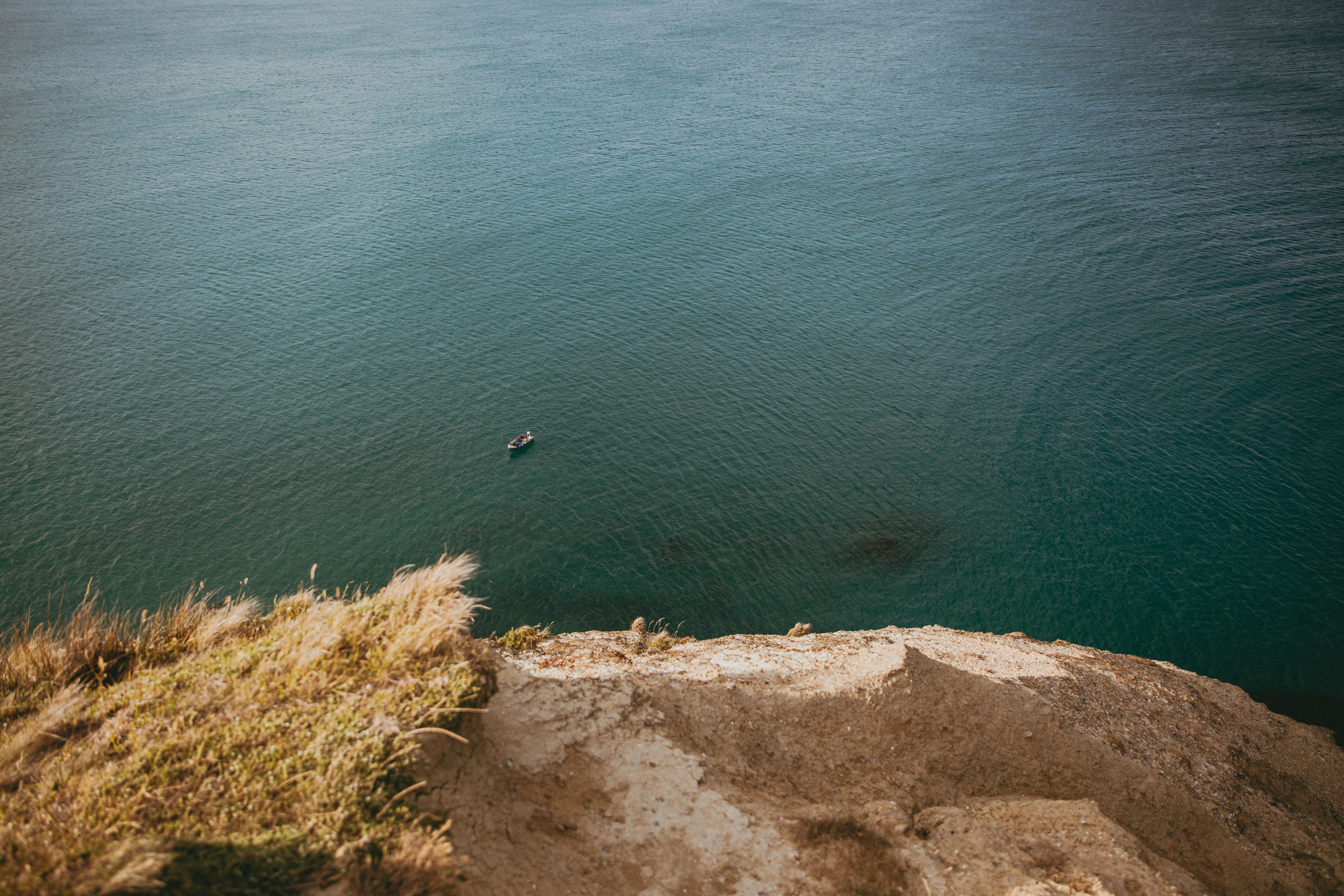 Stunning Cliffside View Over Serene Ocean Waters · Free Stock Photo