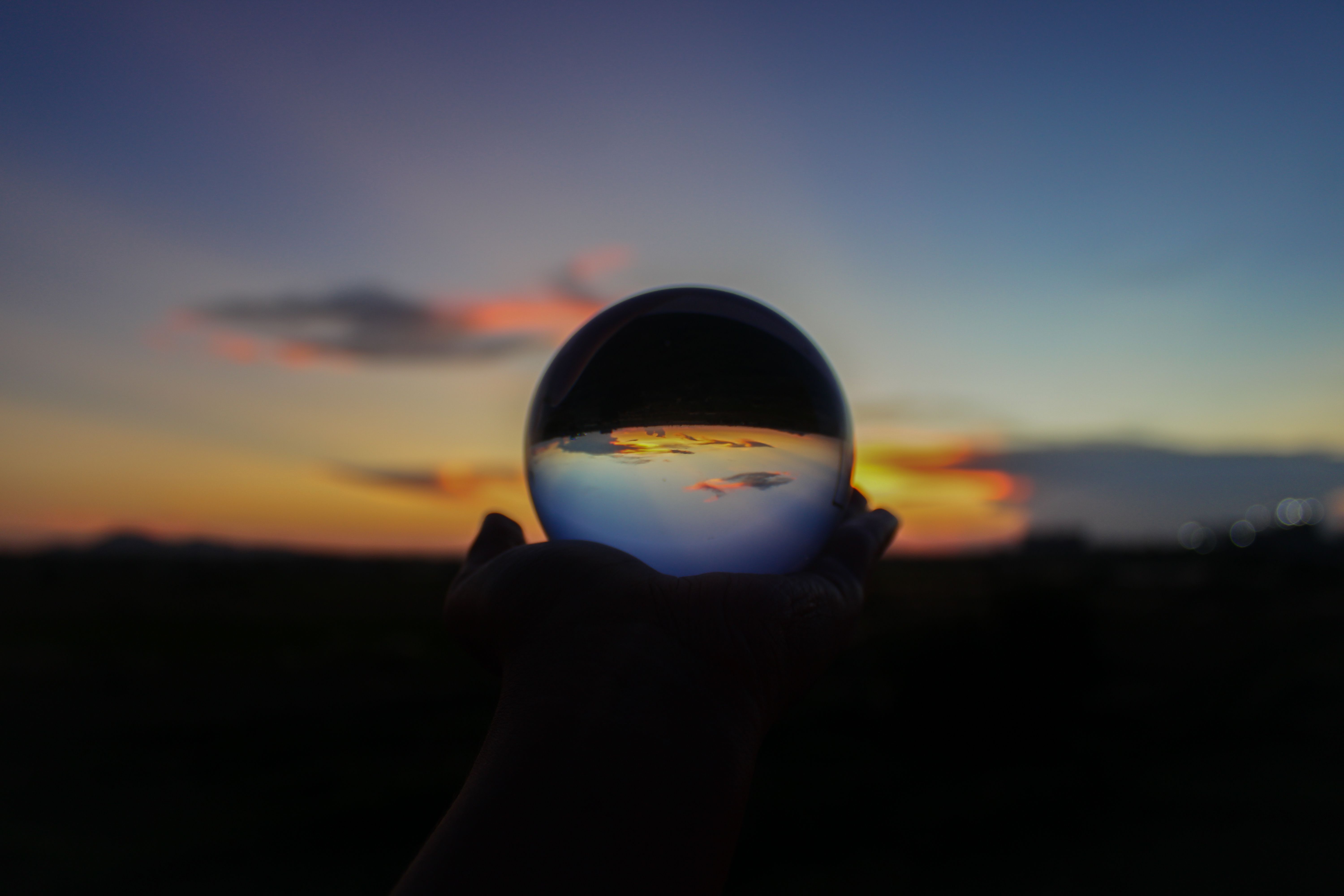 Captivating Sunset Through Lens Ball Reflection · Free Stock Photo
