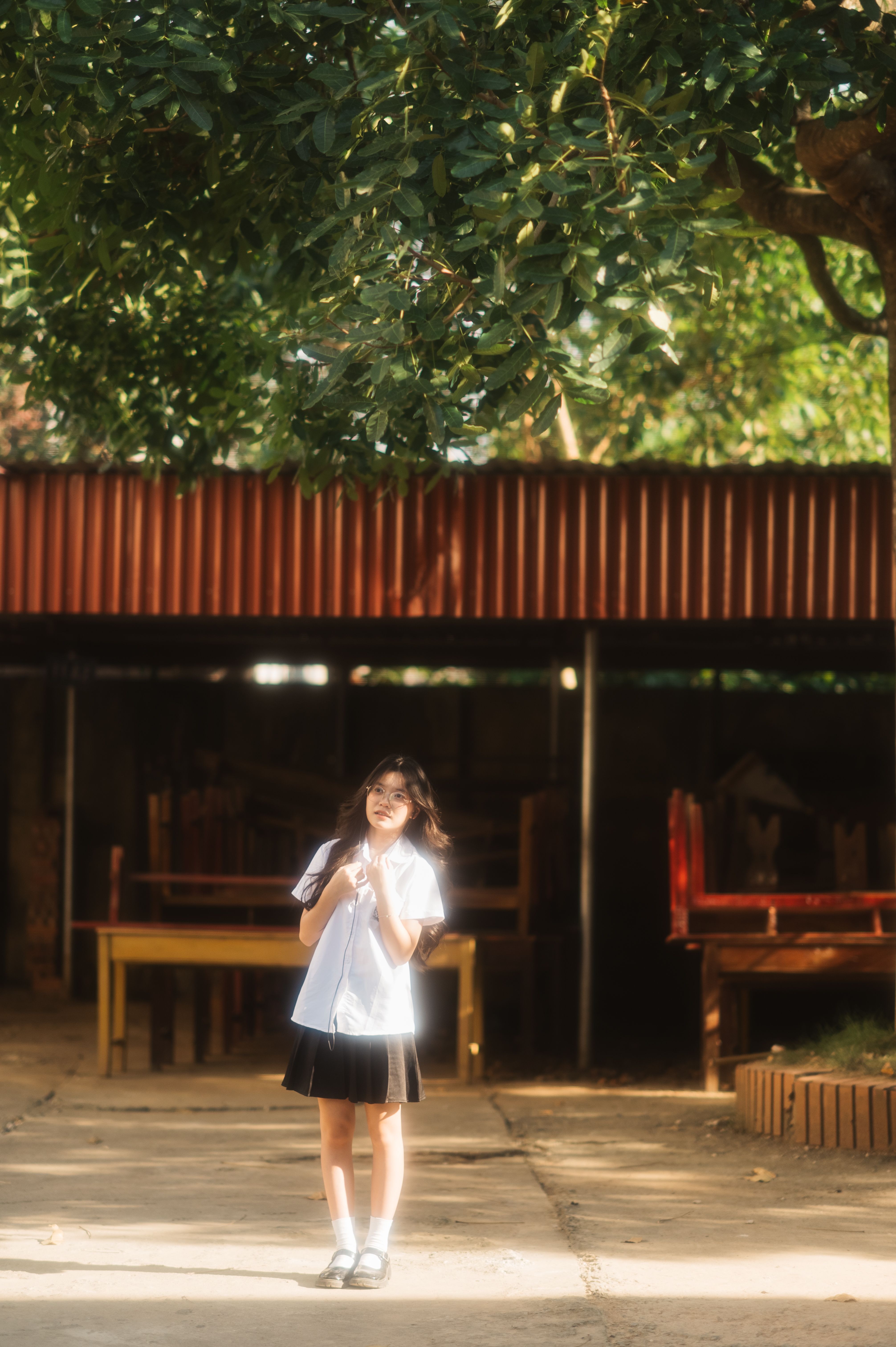 Girl in School Uniform Under a Tree Outdoors · Free Stock Photo