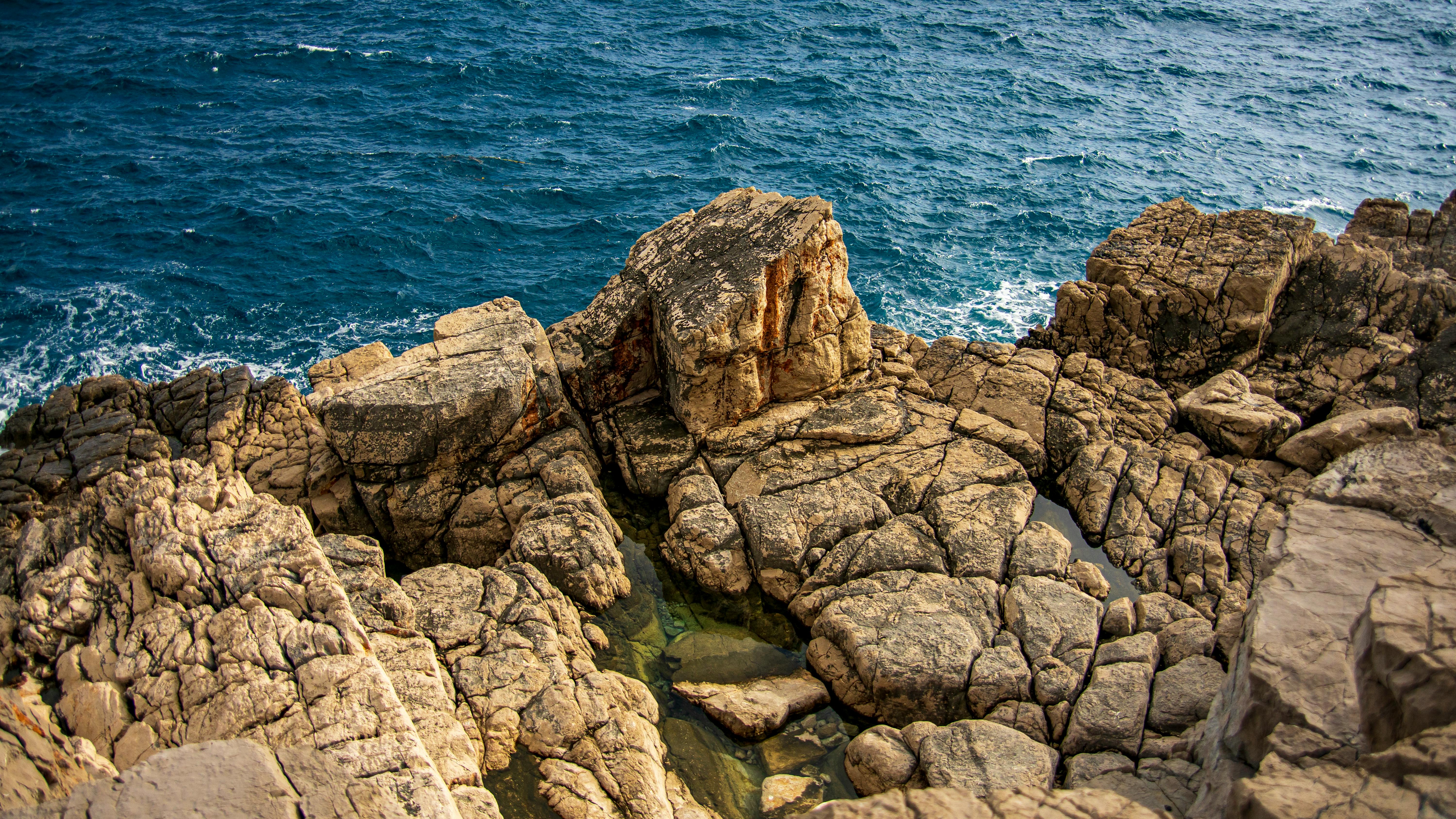 Rugged Coastal Rock Formation with Ocean Waves · Free Stock Photo