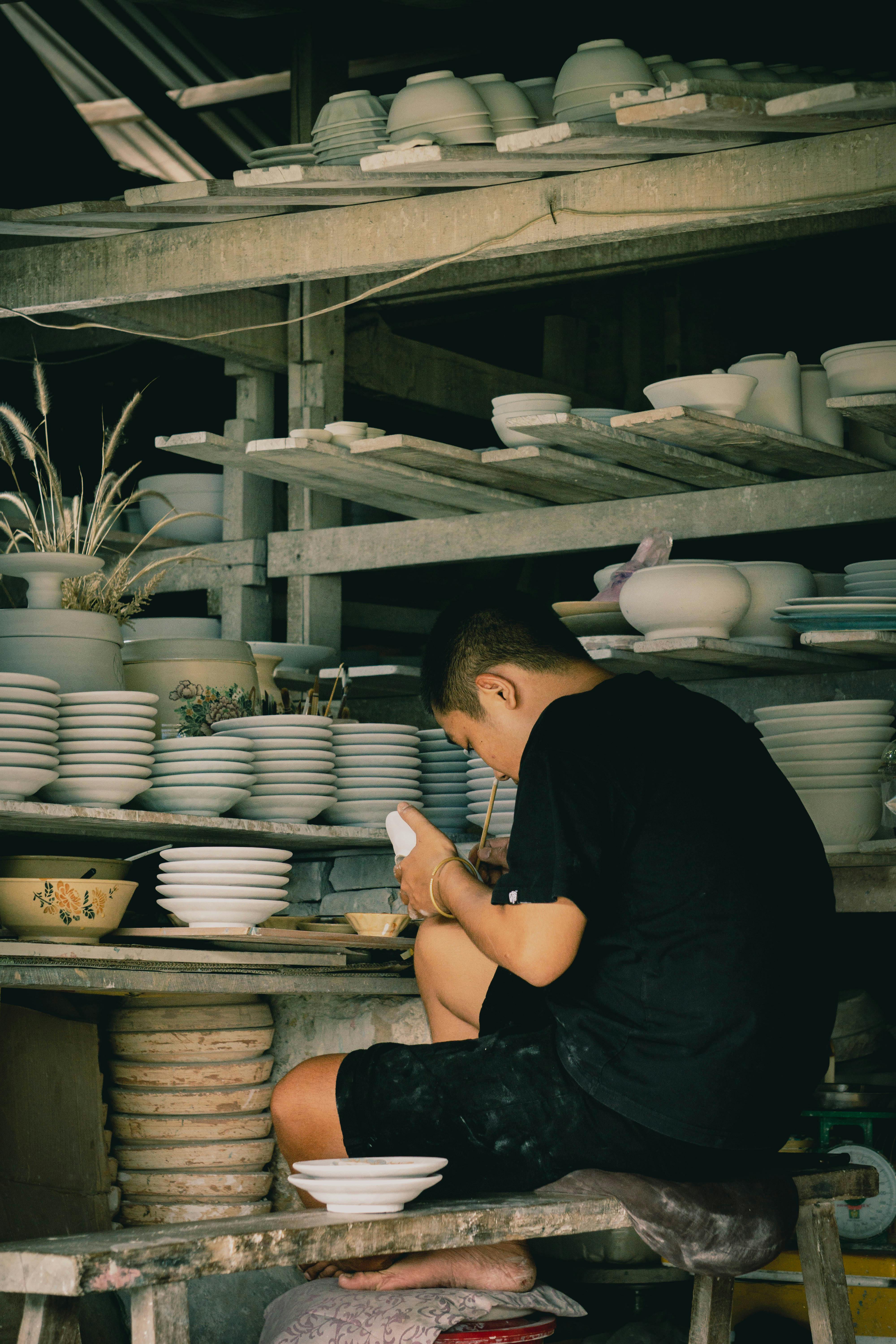 Artisan Crafting Porcelain Dishes in Workshop · Free Stock Photo