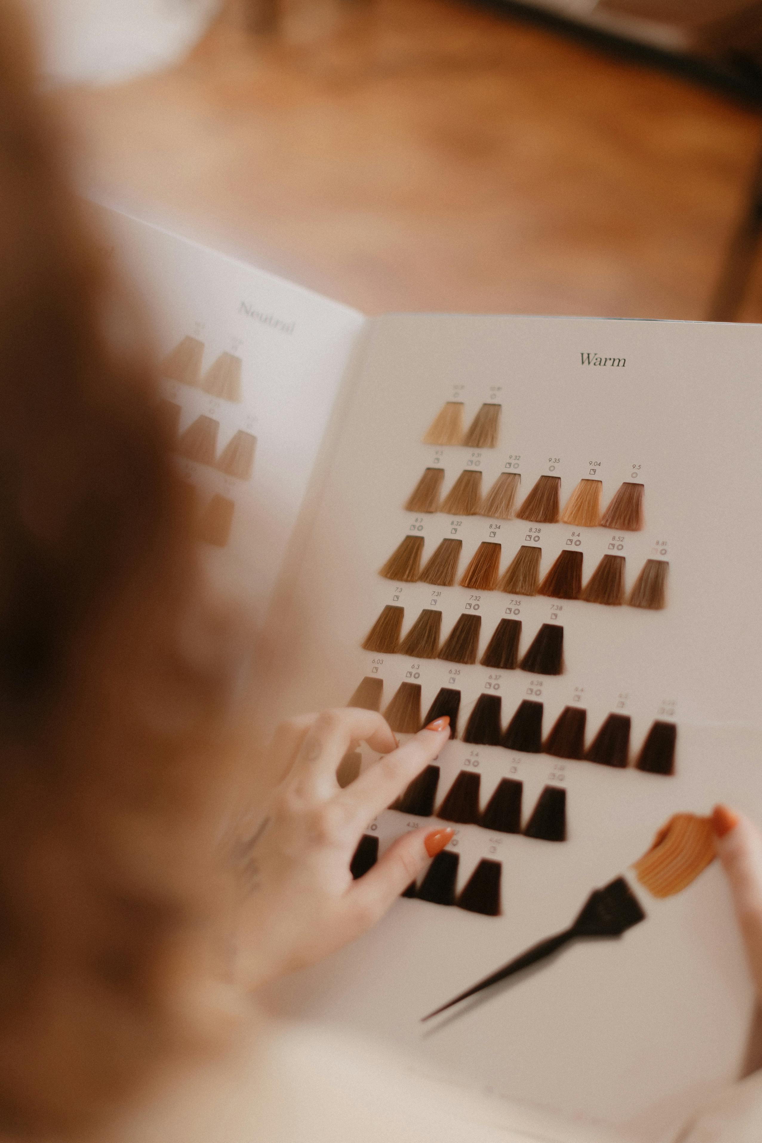 Person Choosing Hair Color from Sample Palette · Free Stock Photo