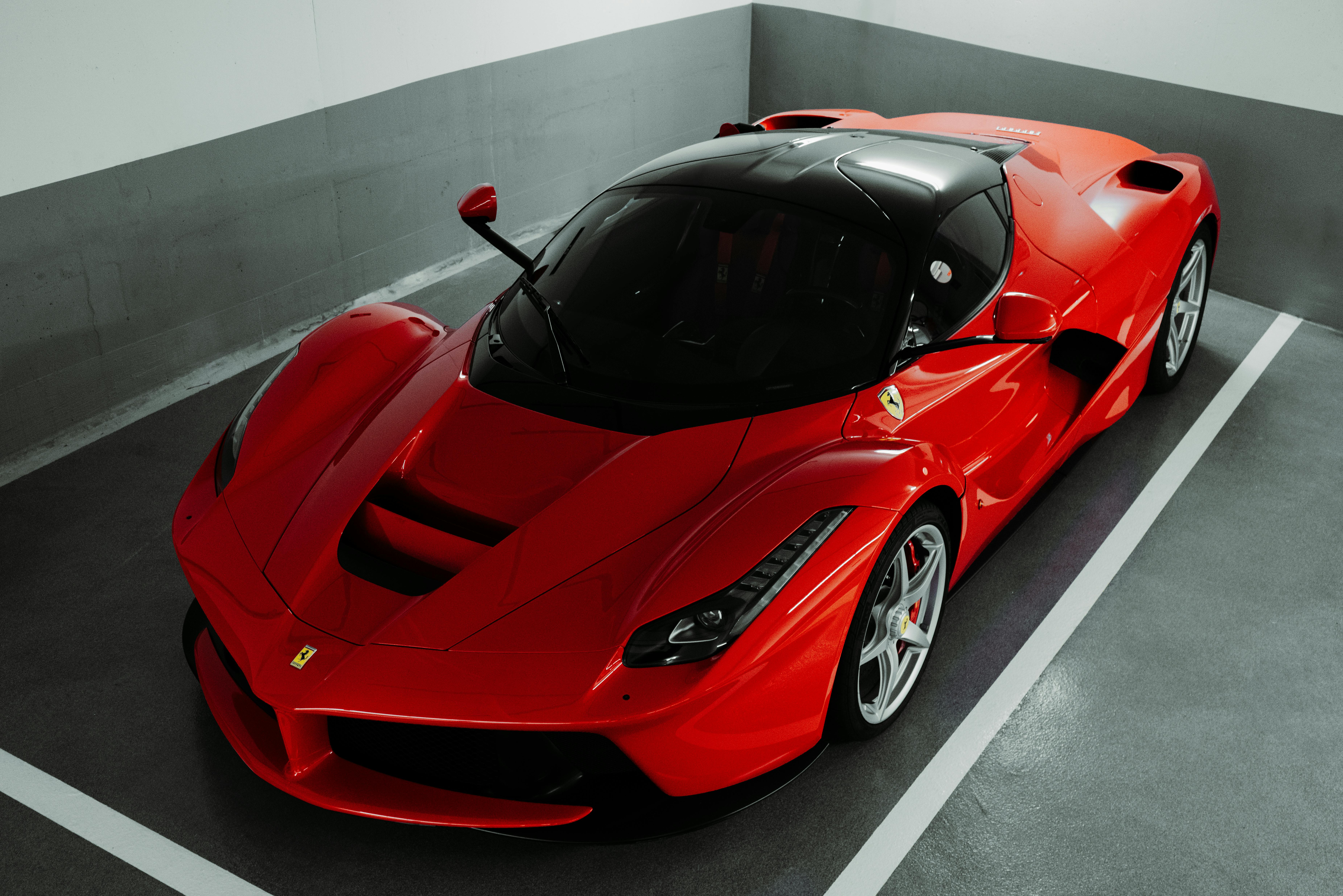 Sleek Red Ferrari Supercar in Indoor Garage · Free Stock Photo