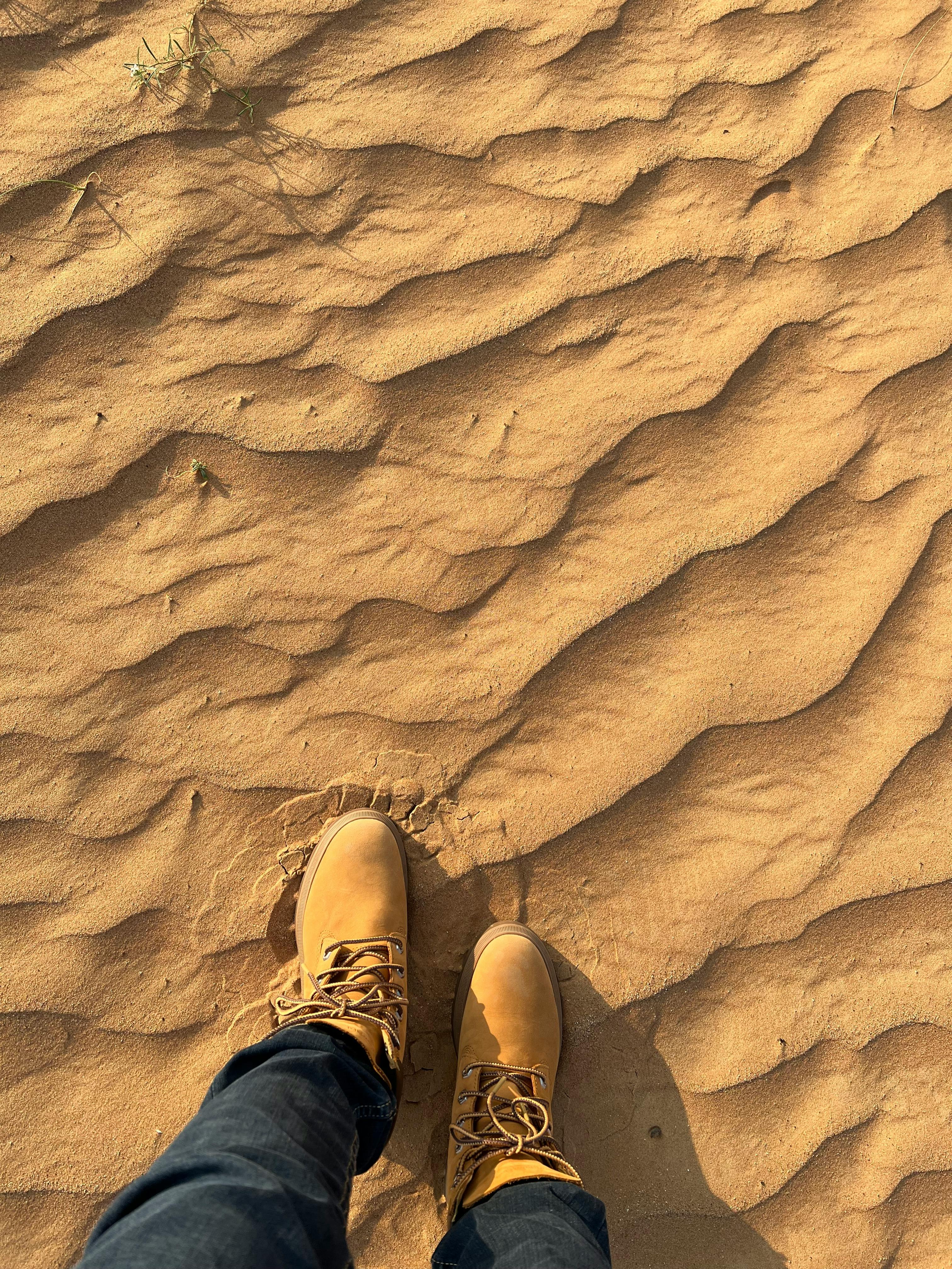 Walking Across Desert Sand Dunes in Boots · Free Stock Photo