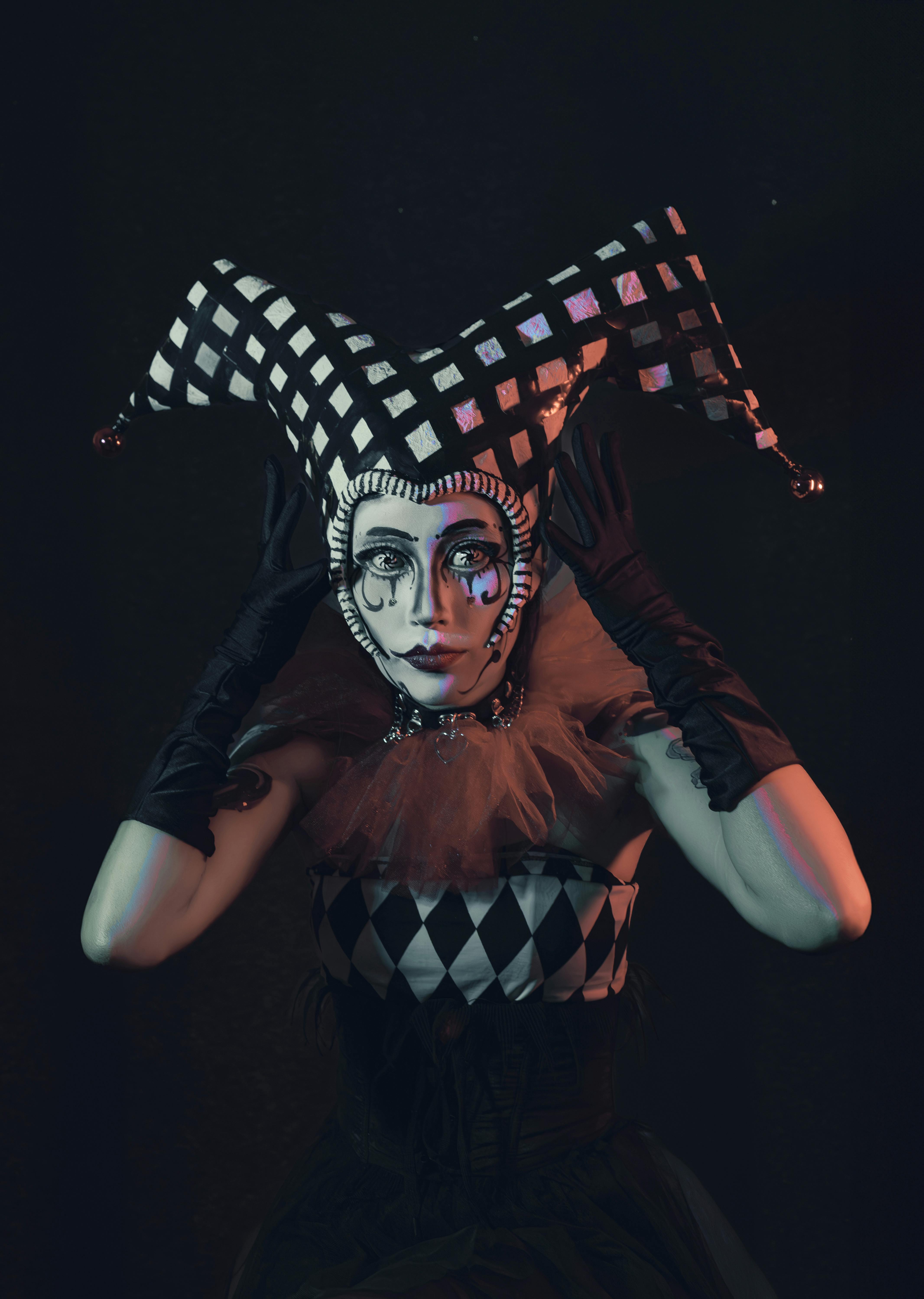 Harlequin Costume Makeup Portrait in Low Light · Free Stock Photo