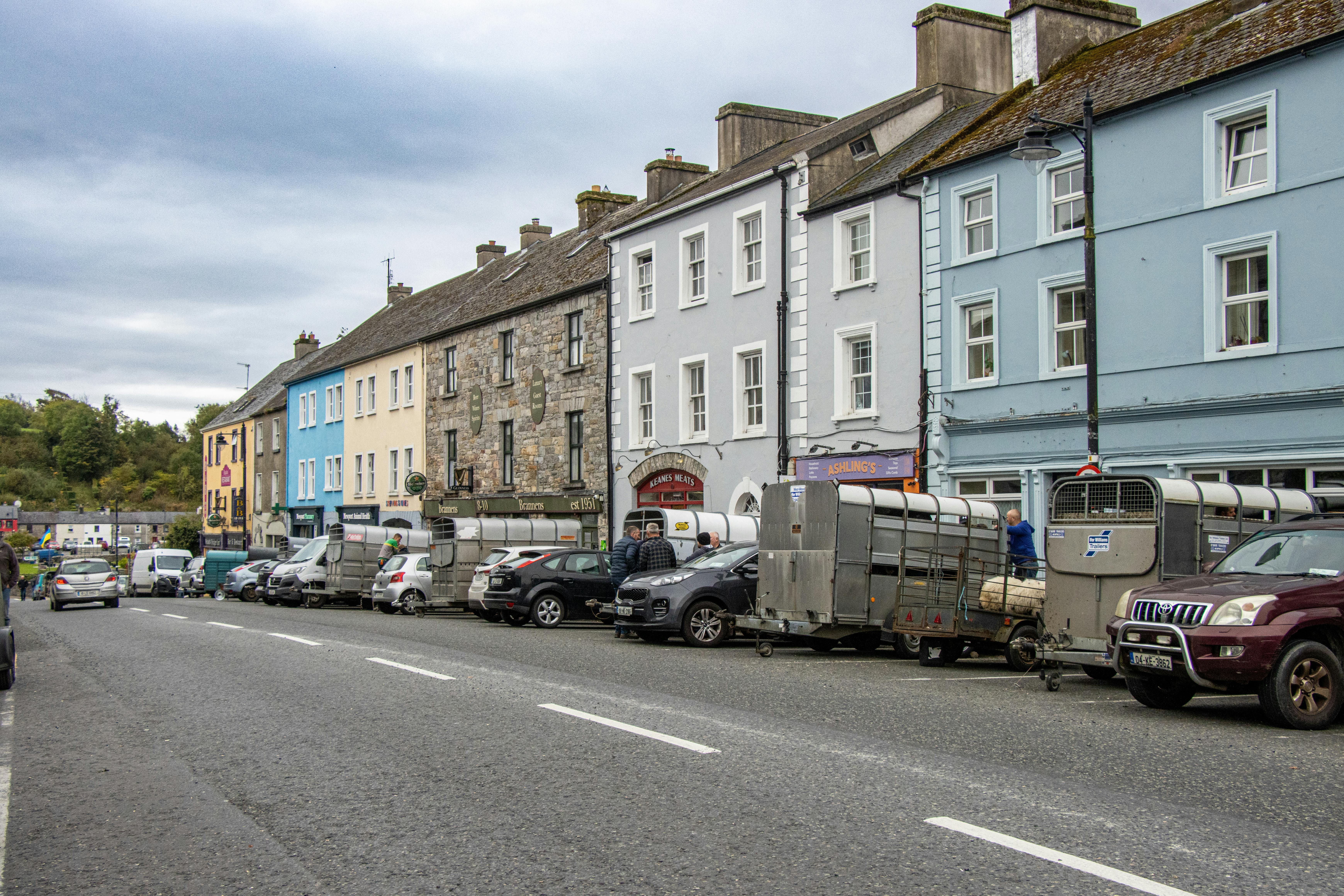 Colorful Street in Irish Town with Parked Vehicles · Free Stock Photo