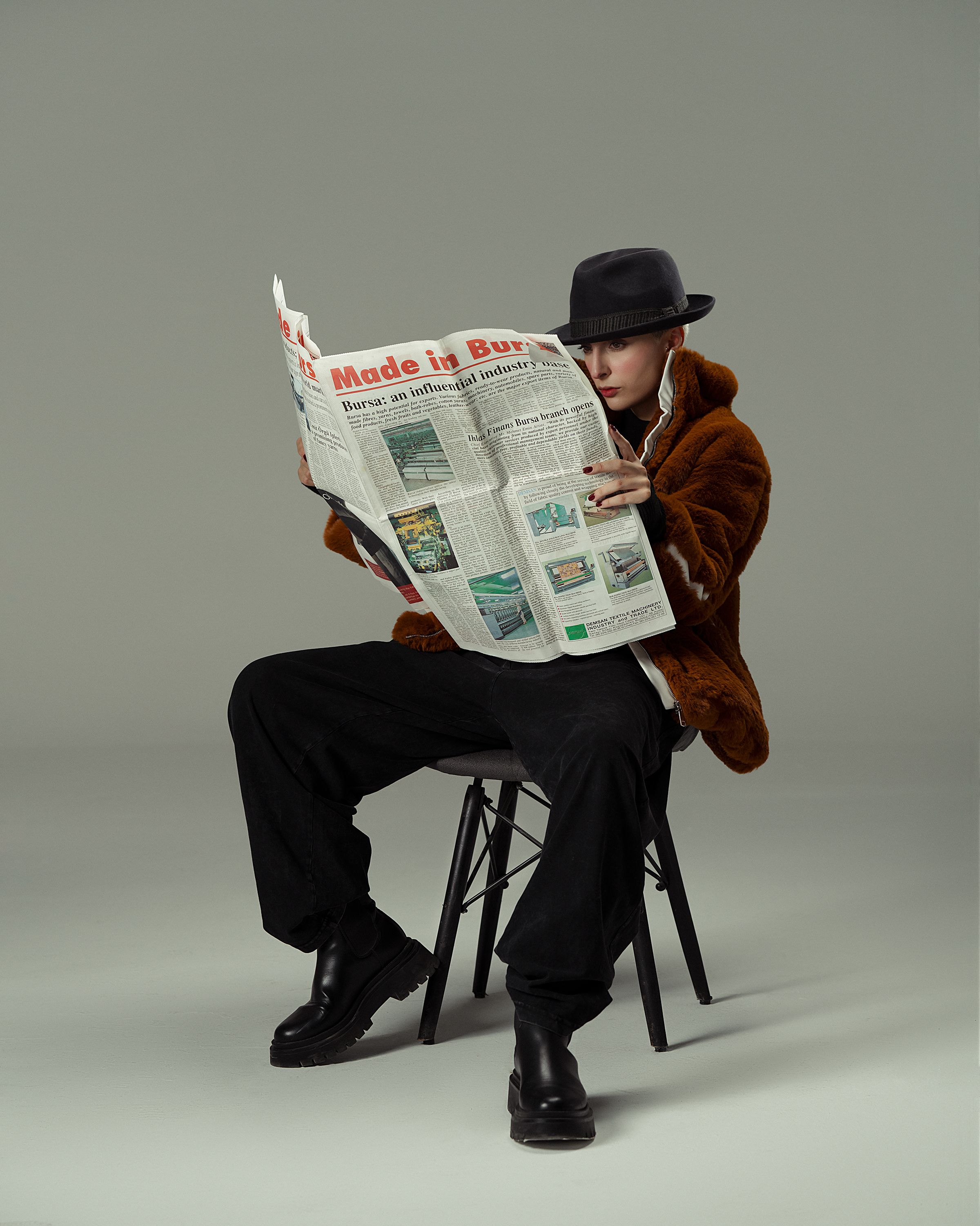 Stylish Woman Reading Newspaper in Studio · Free Stock Photo