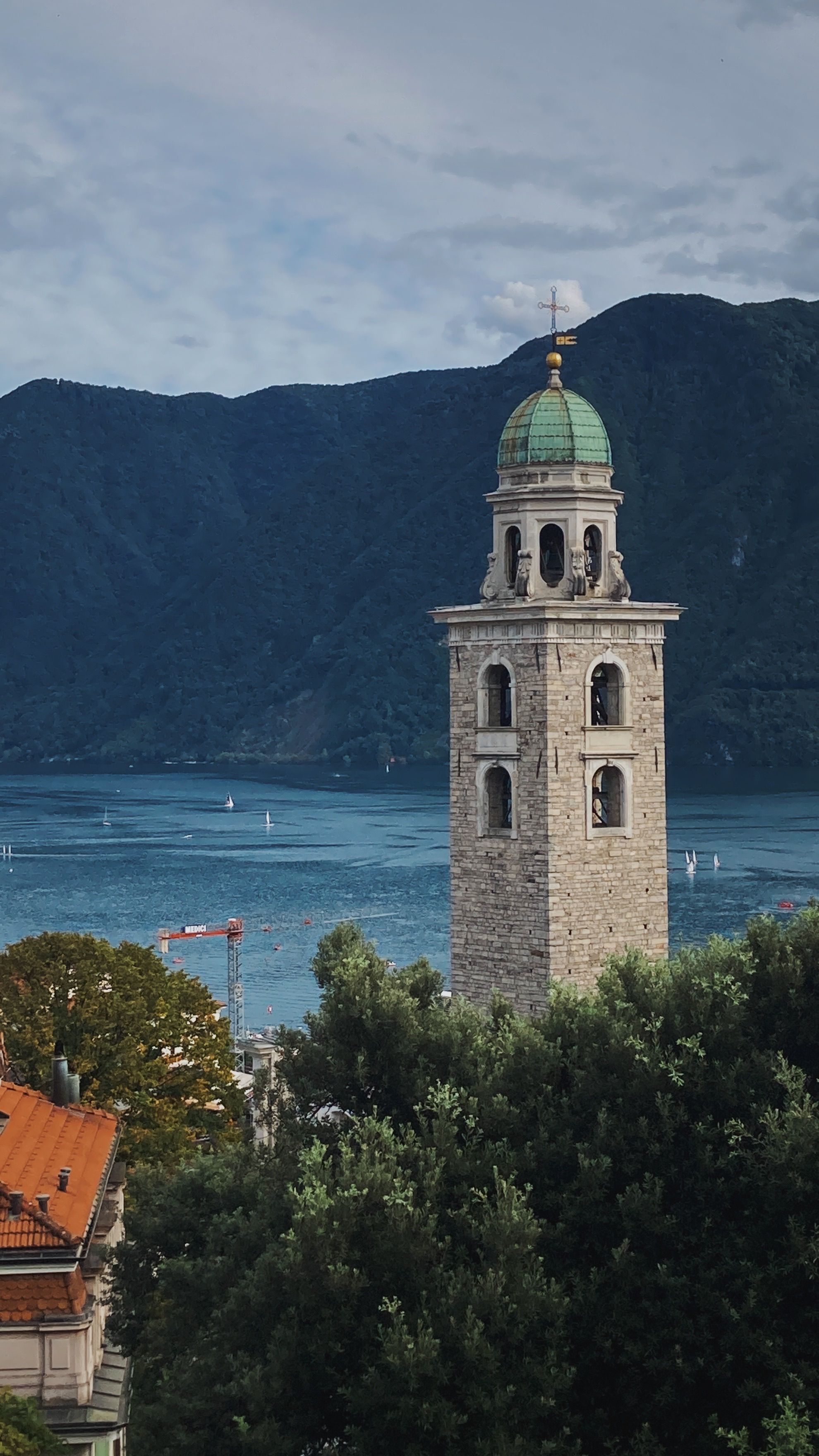 Historic Tower Overlooking Scenic Lake and Mountains · Free Stock Photo
