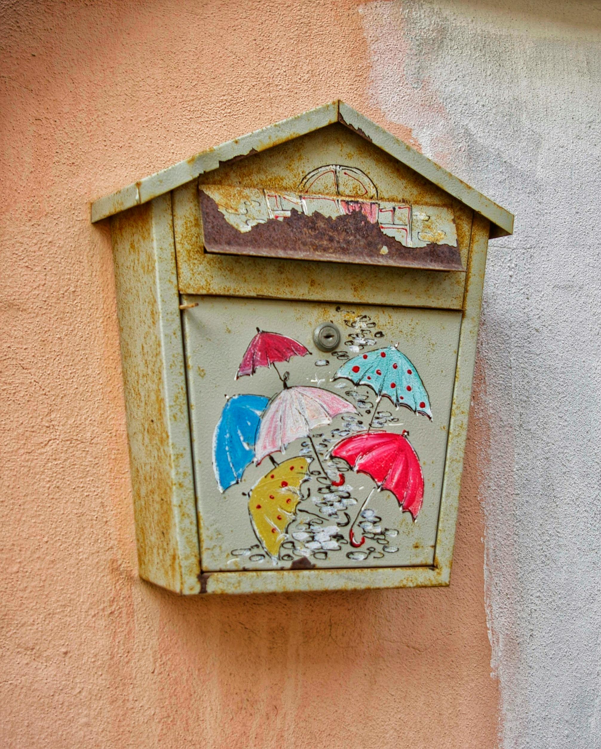 Colorful Umbrella Art on Rustic Mailbox · Free Stock Photo