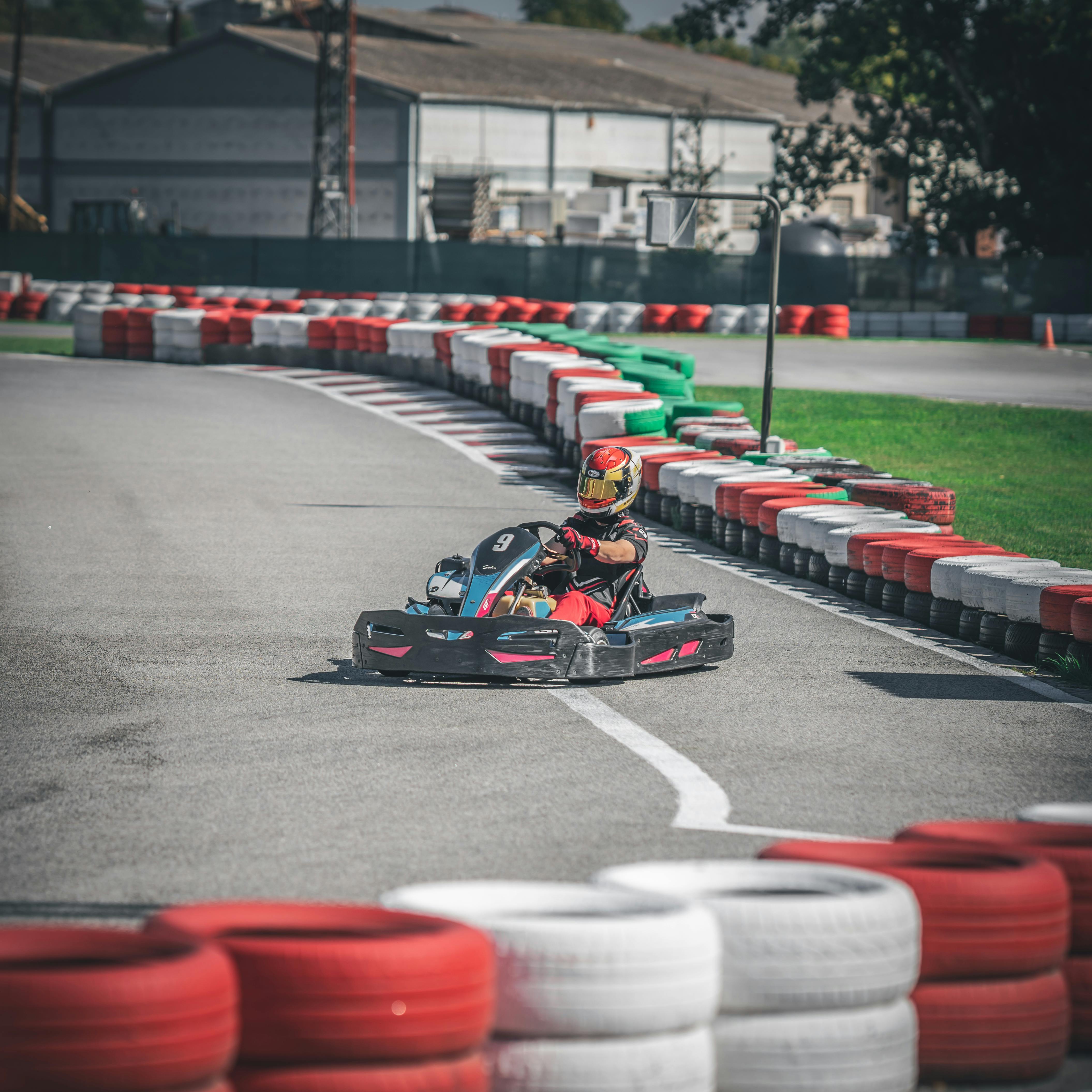 Exciting Go-Kart Racing on Outdoor Track · Free Stock Photo
