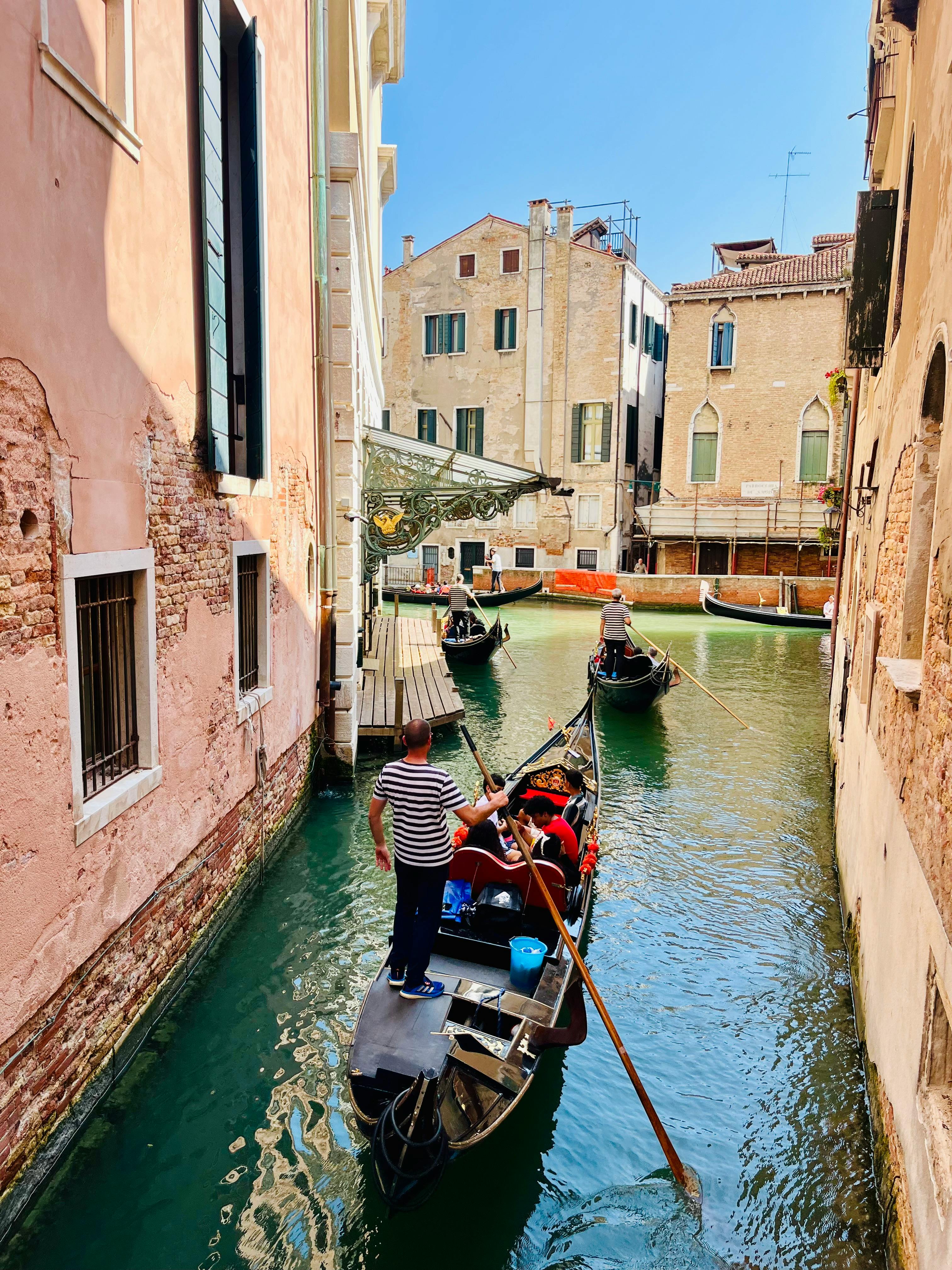 Scenic Gondola Ride in Venetian Canal · Free Stock Photo