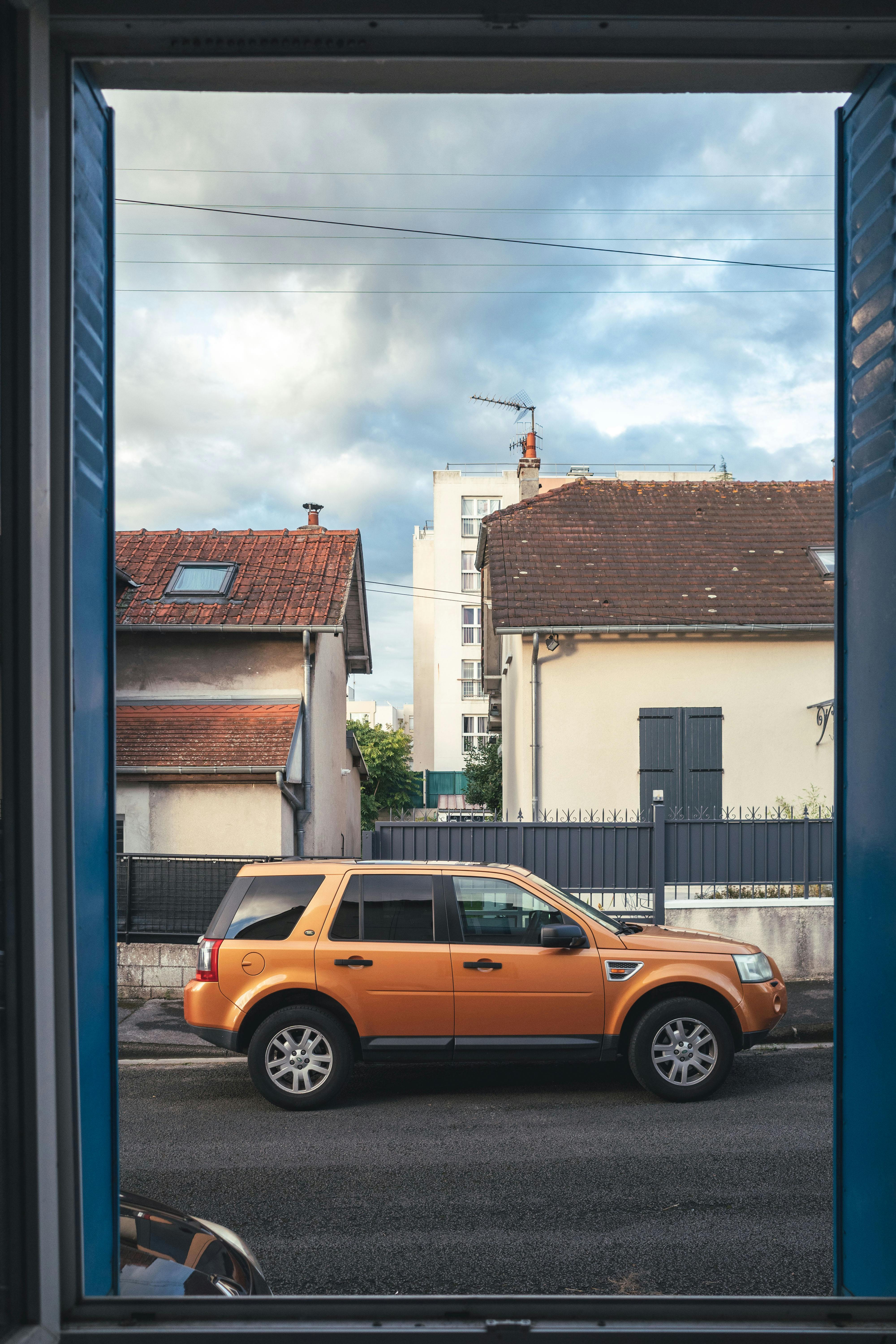Urban Street View Through Window Frame · Free Stock Photo