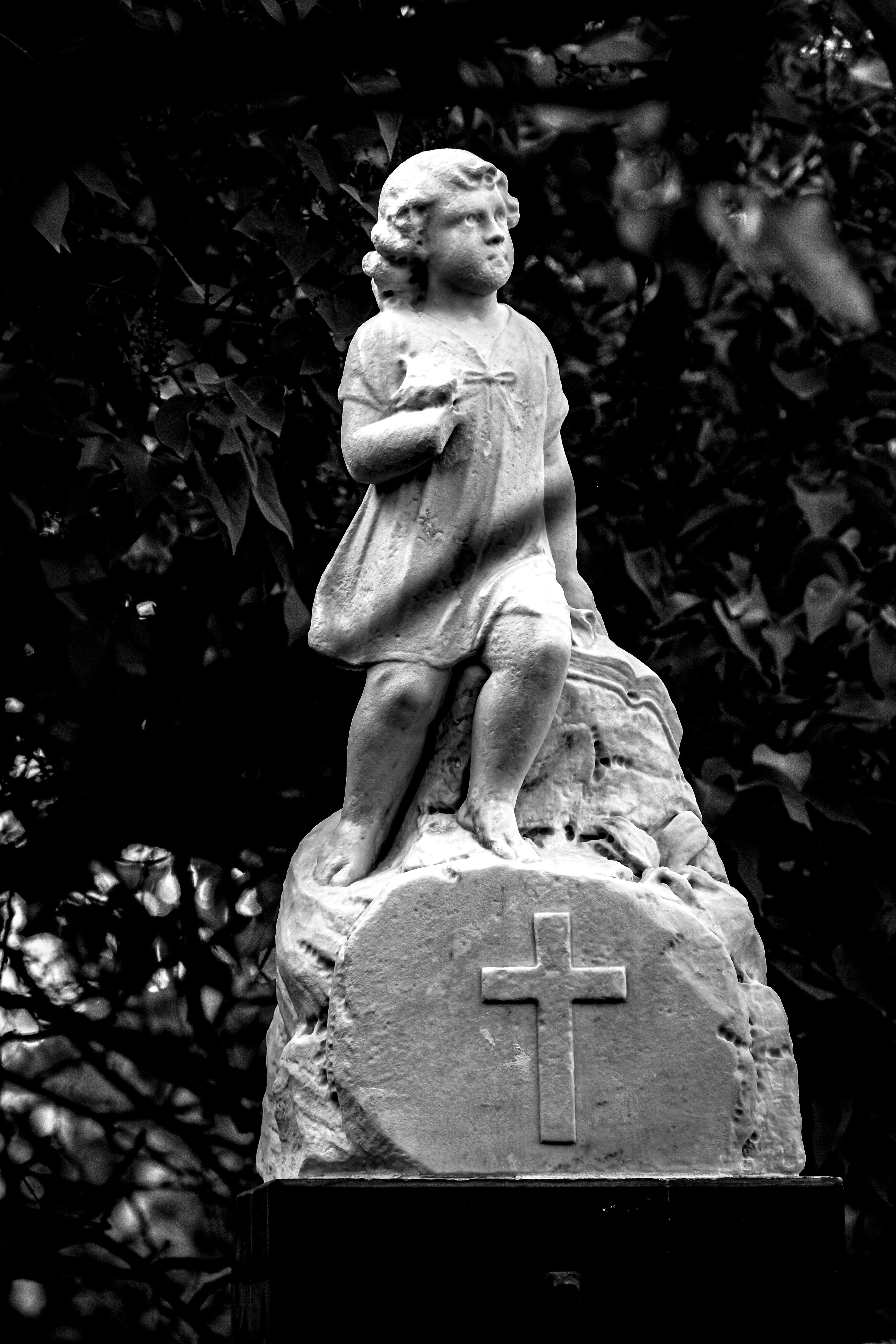 Black and White Religious Statue with Cross · Free Stock Photo