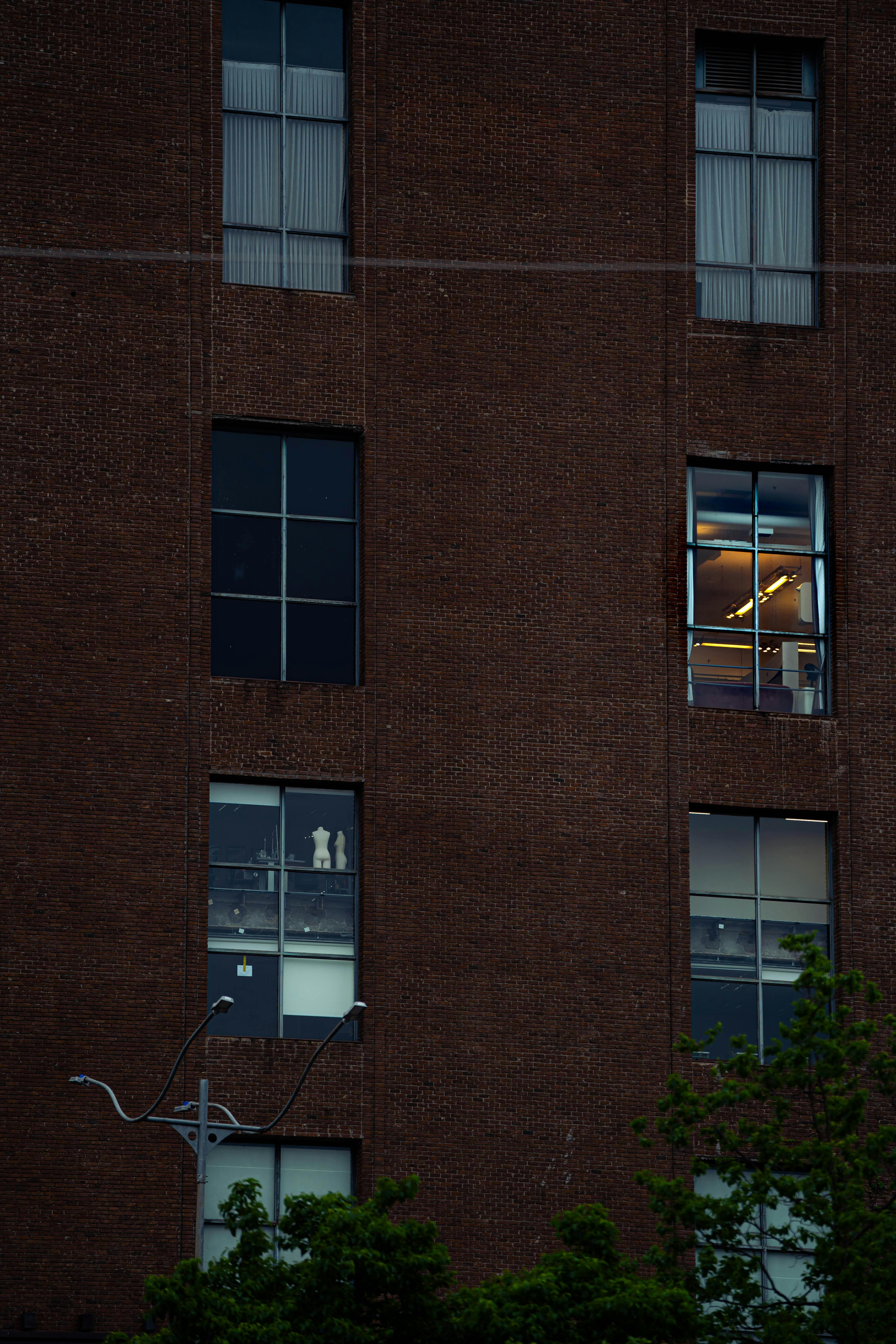 Urban Building Exterior with Illuminated Windows · Free Stock Photo