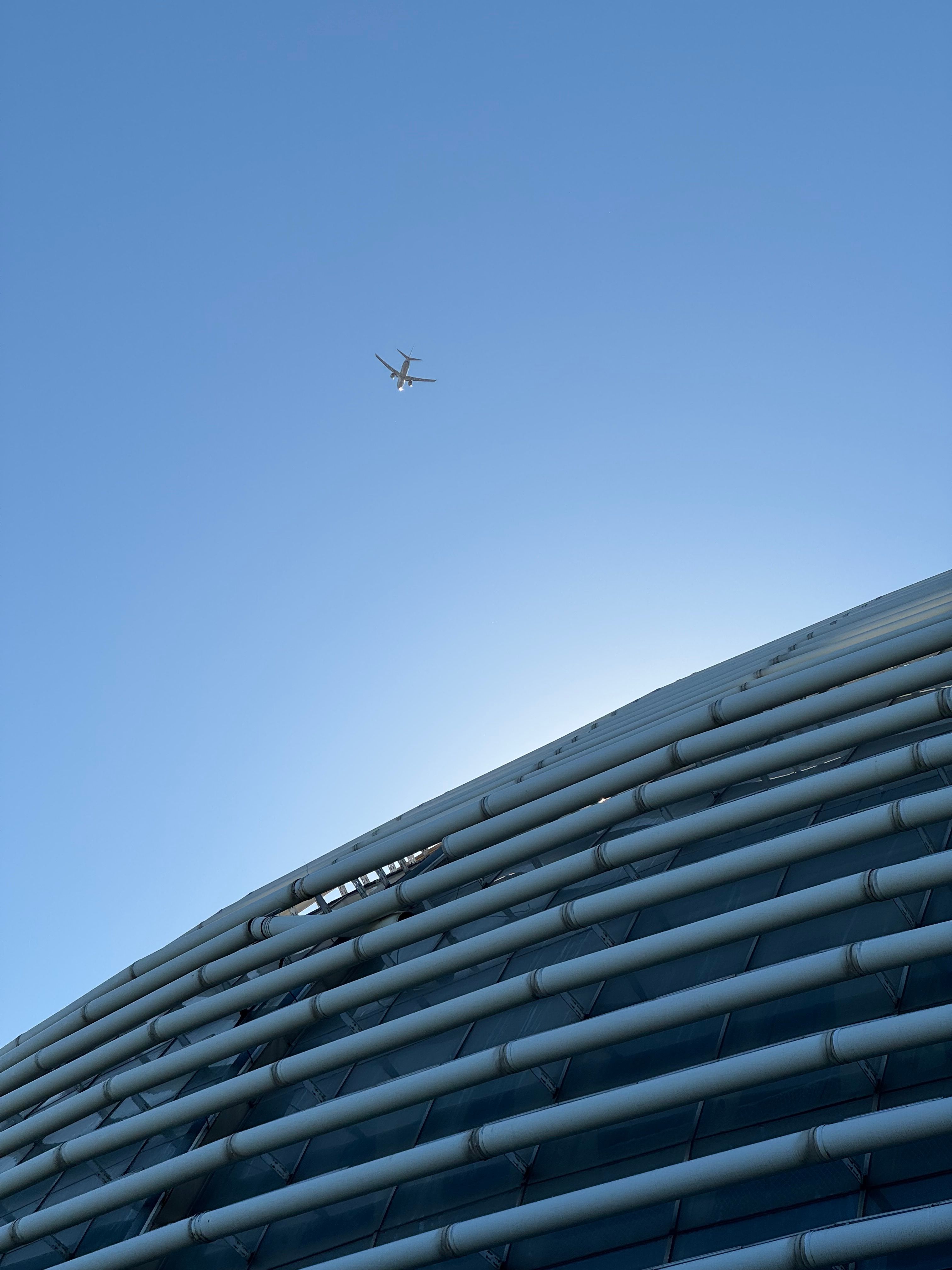 Airplane over Modern Architecture in Tianjin · Free Stock Photo