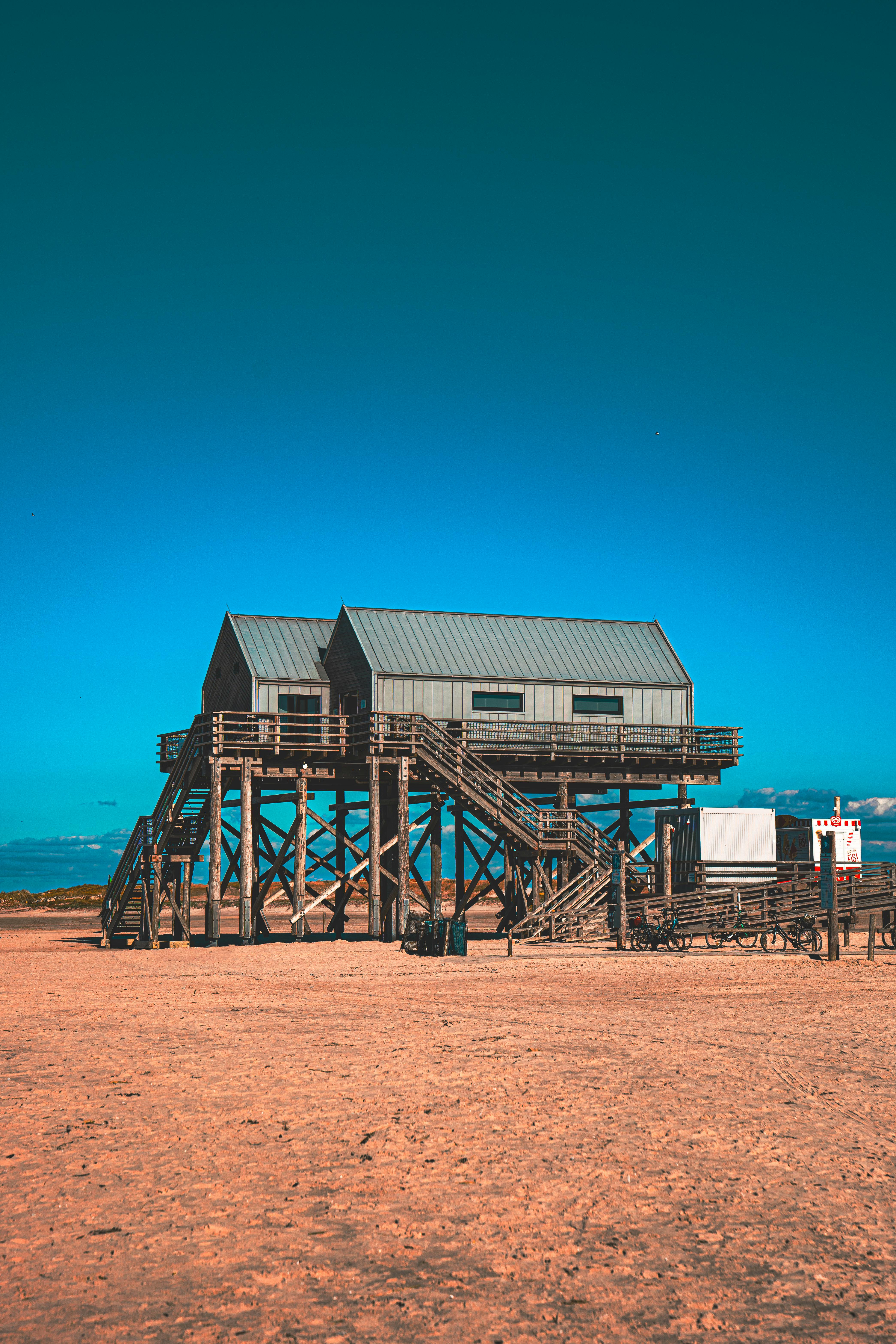 Stilted Beach House Against Clear Blue Sky · Free Stock Photo
