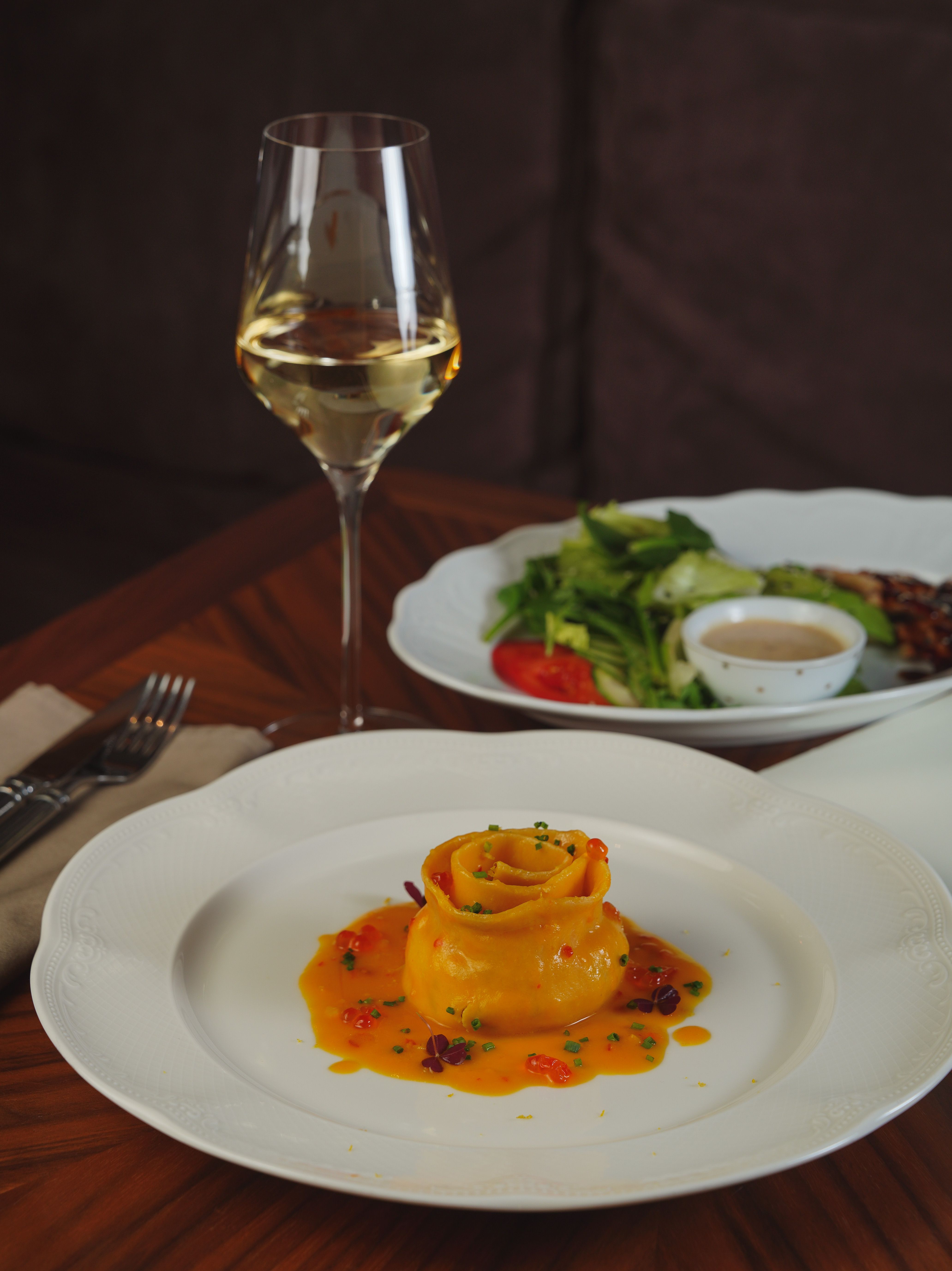 Gourmet Dish with Wine and Salad in Elegant Setting · Free Stock Photo