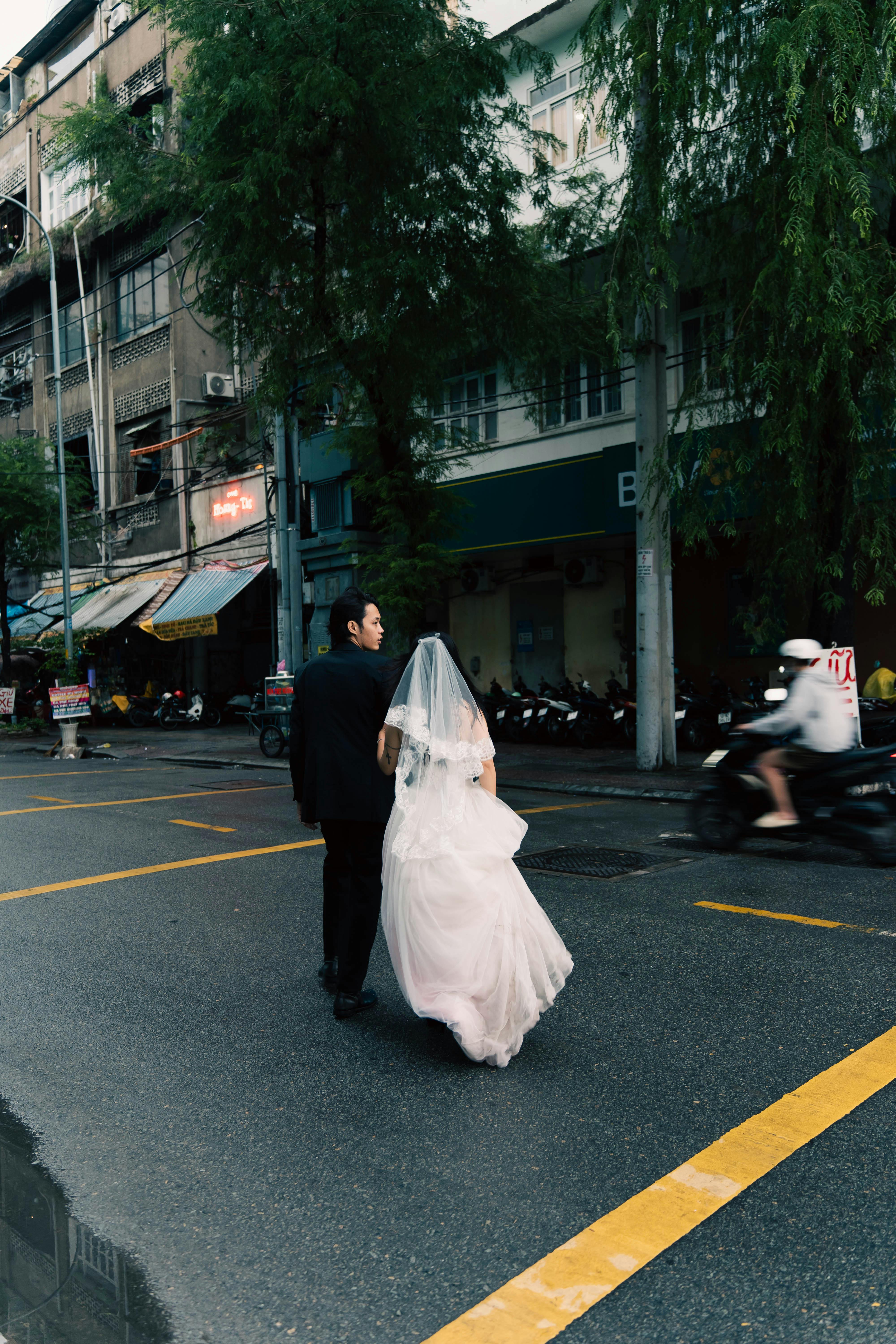 Bride and Groom Walking on Urban Street · Free Stock Photo