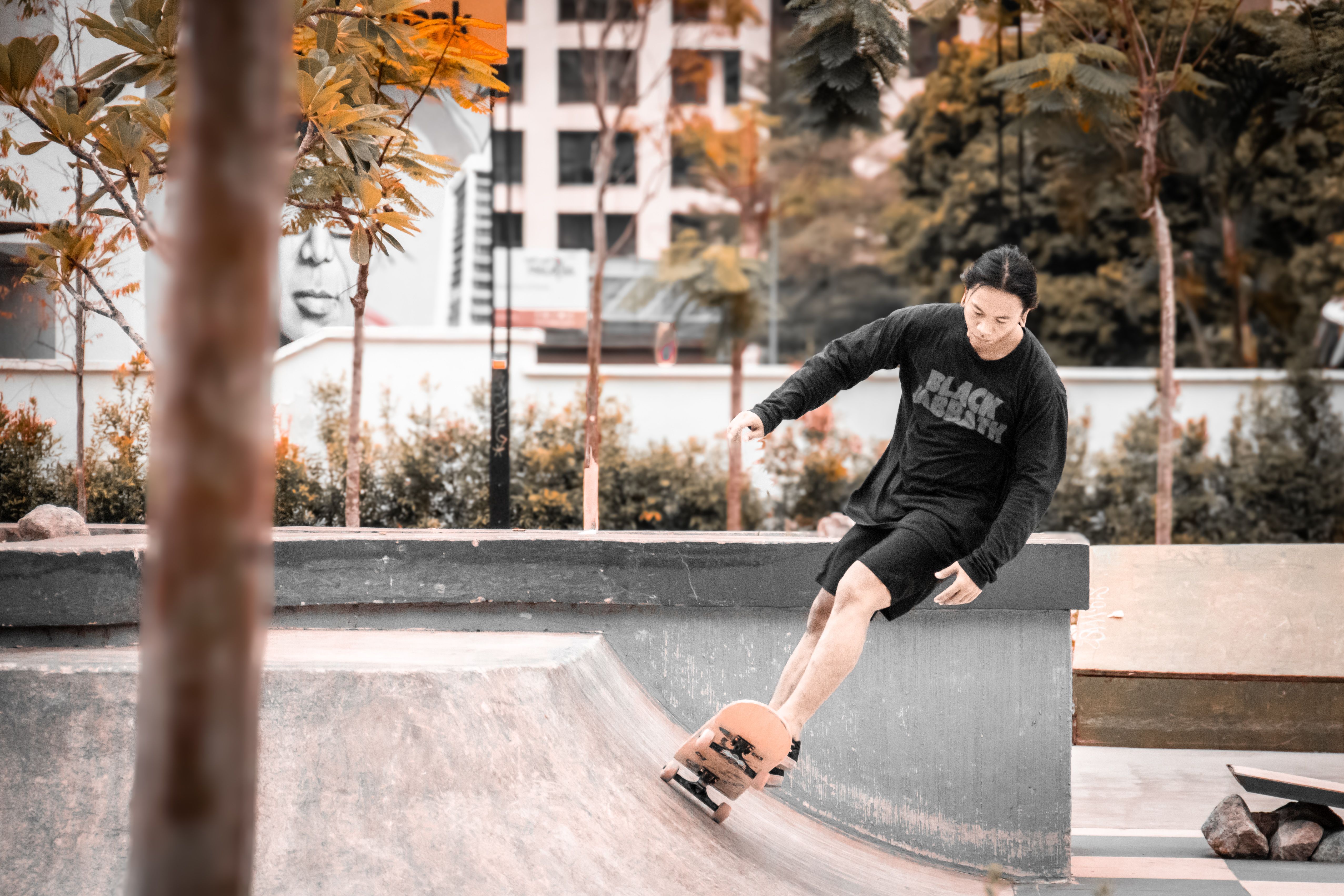 Skateboarder Performing Trick in Urban Skate Park · Free Stock Photo