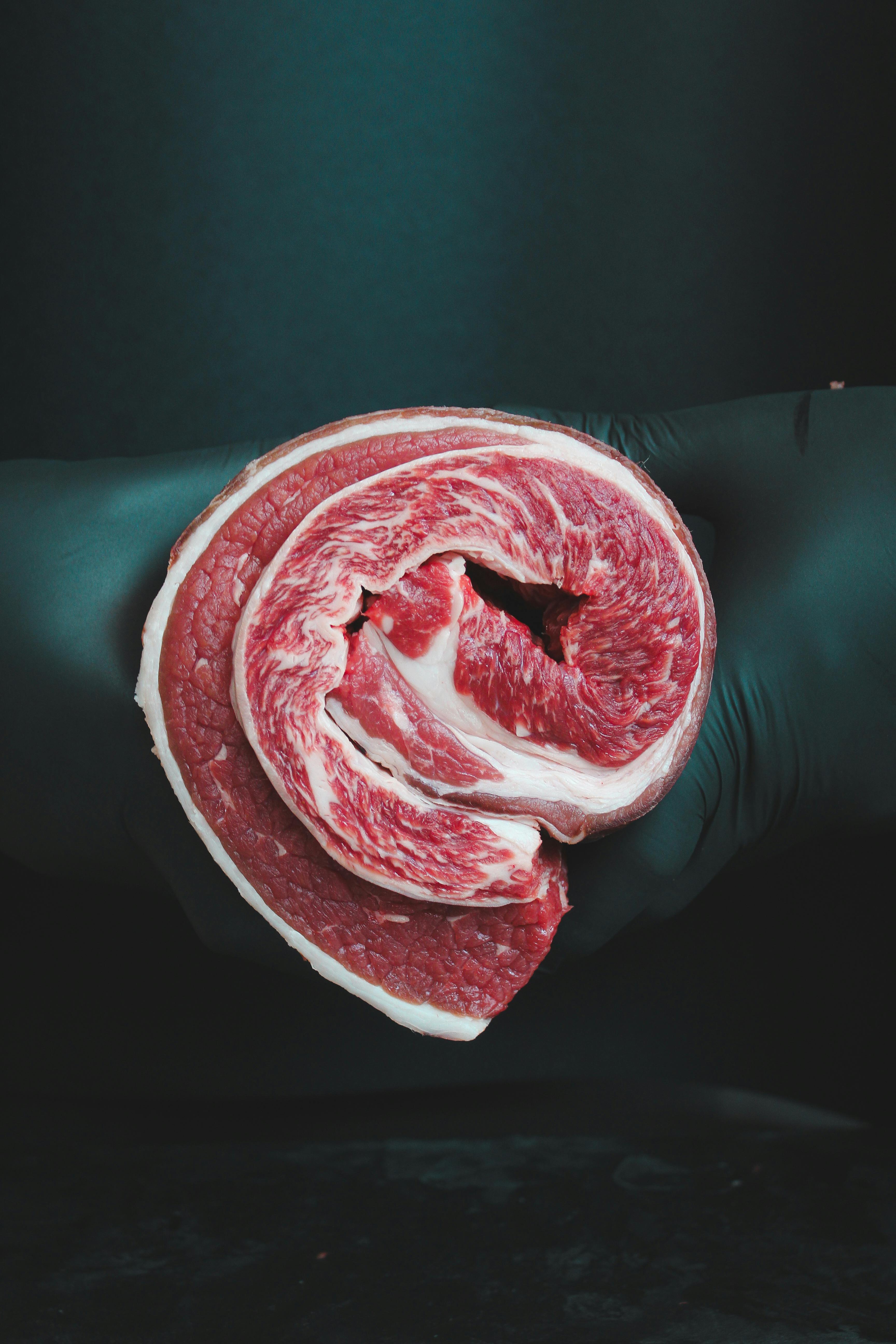 Raw Fresh Meat Slice Displayed on Black · Free Stock Photo
