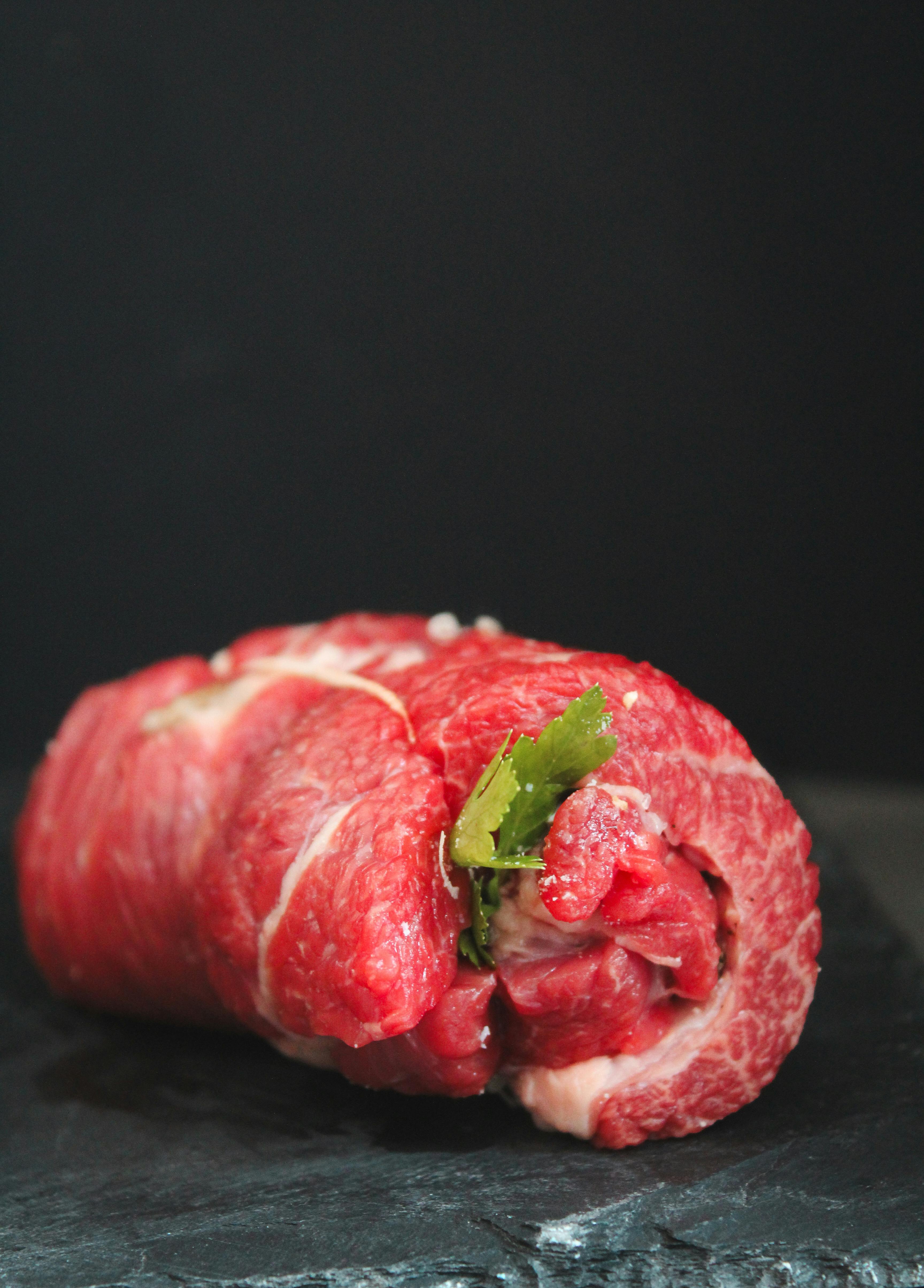 Rolled Raw Beef on Dark Slate Surface · Free Stock Photo