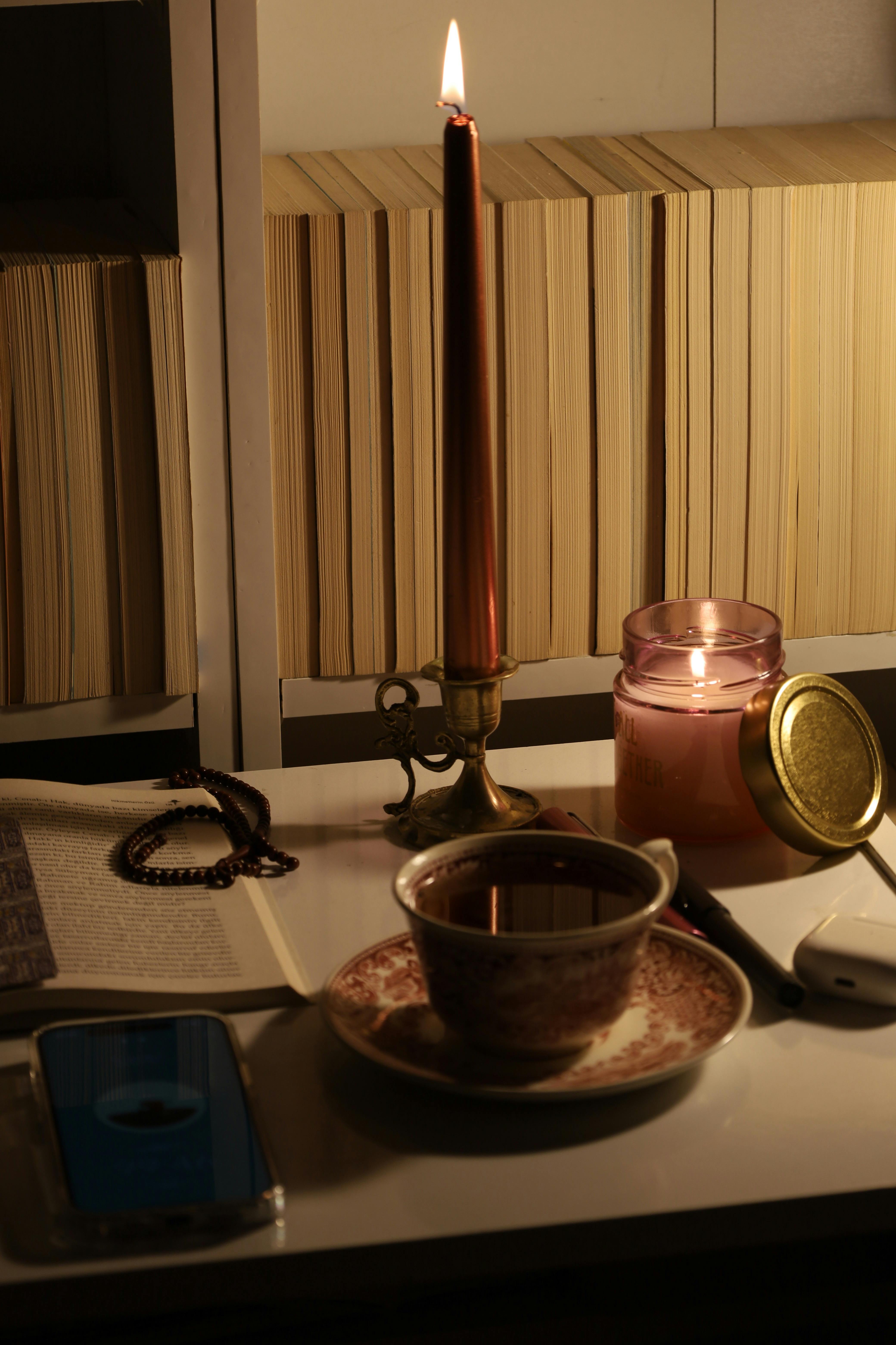 Cozy Candlelit Reading Nook with Tea · Free Stock Photo