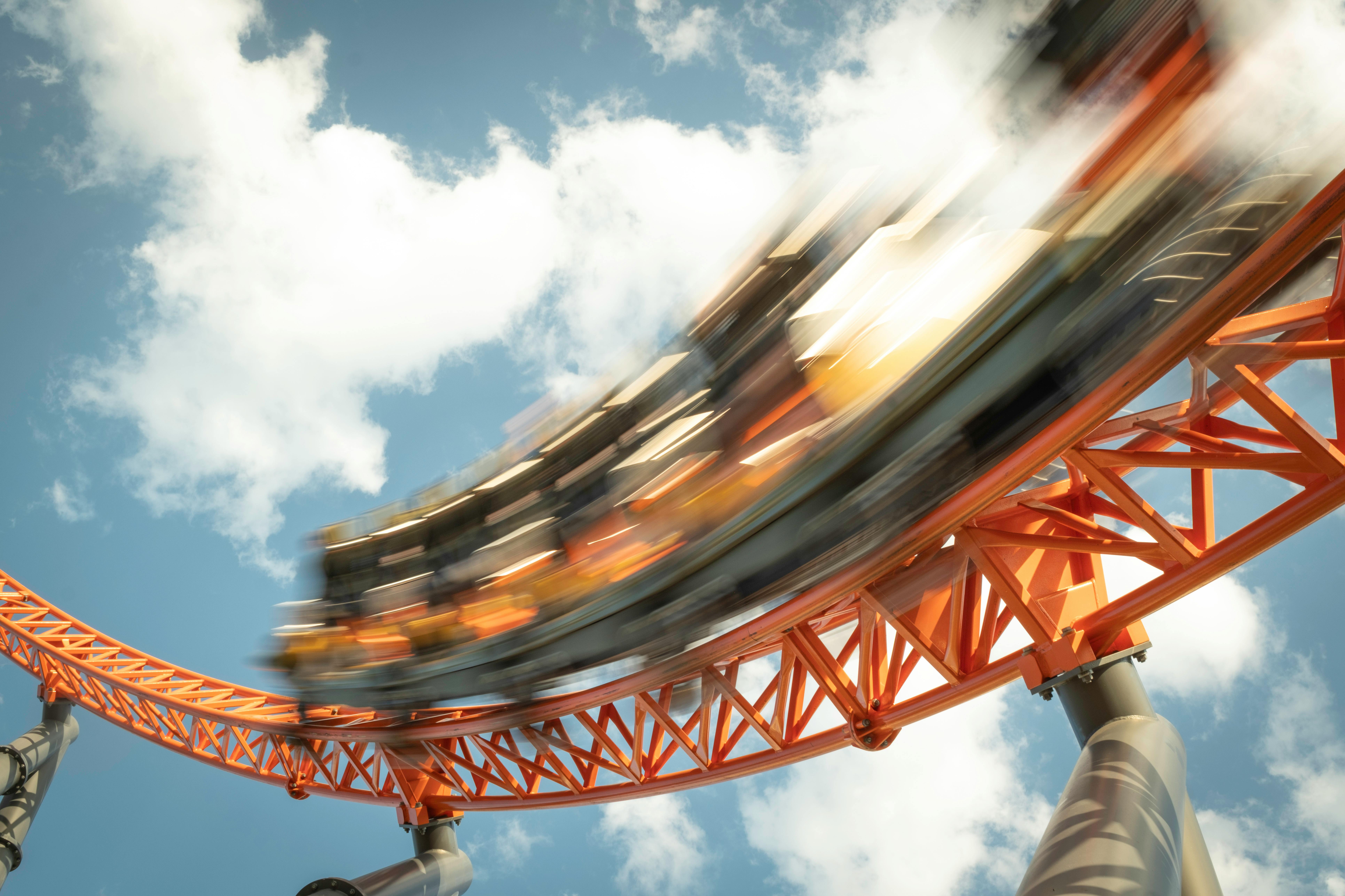Dynamic Roller Coaster in Motion Against Blue Sky · Free Stock Photo